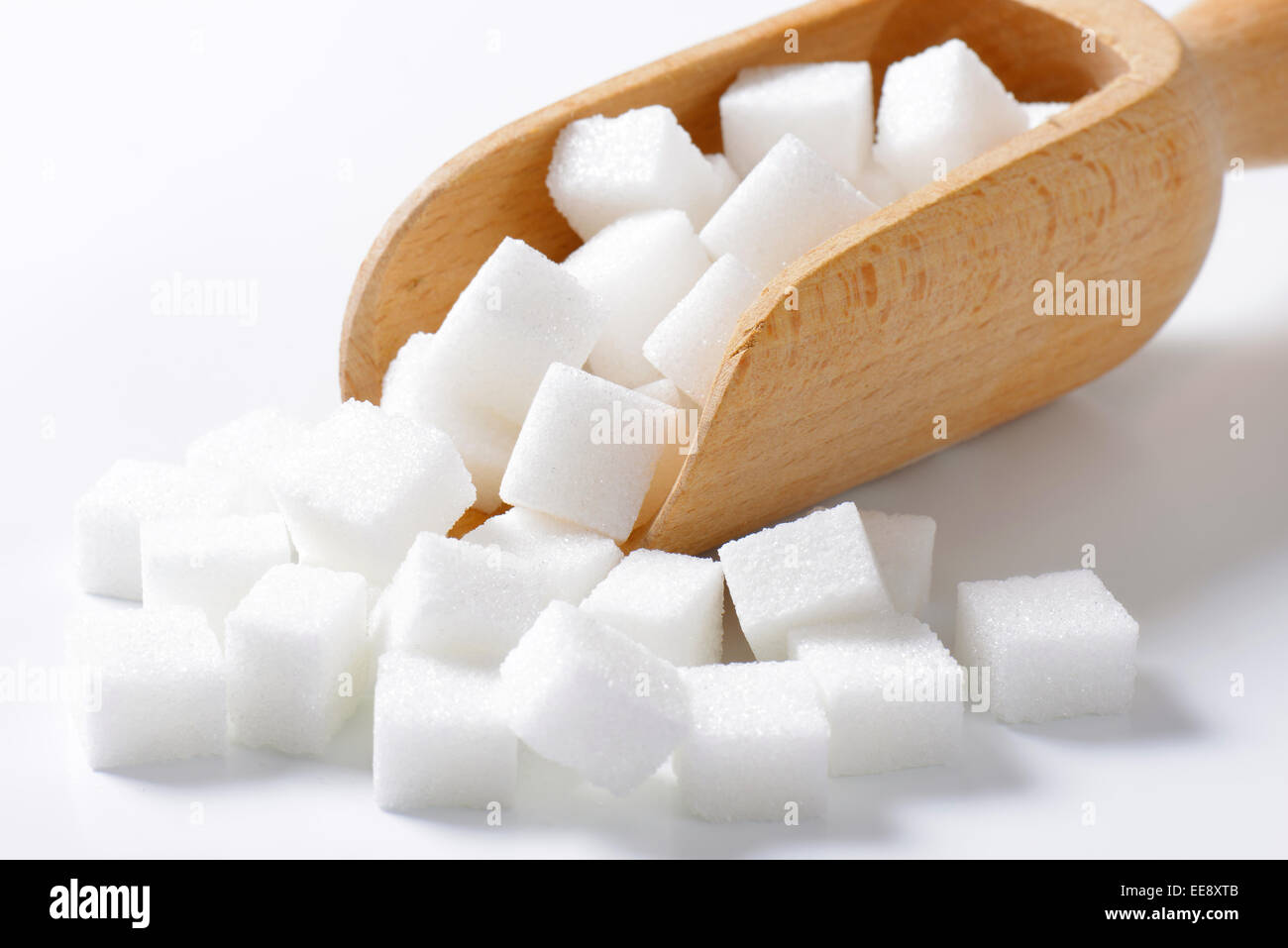 White sugar cubes in wooden scoop Stock Photo - Alamy