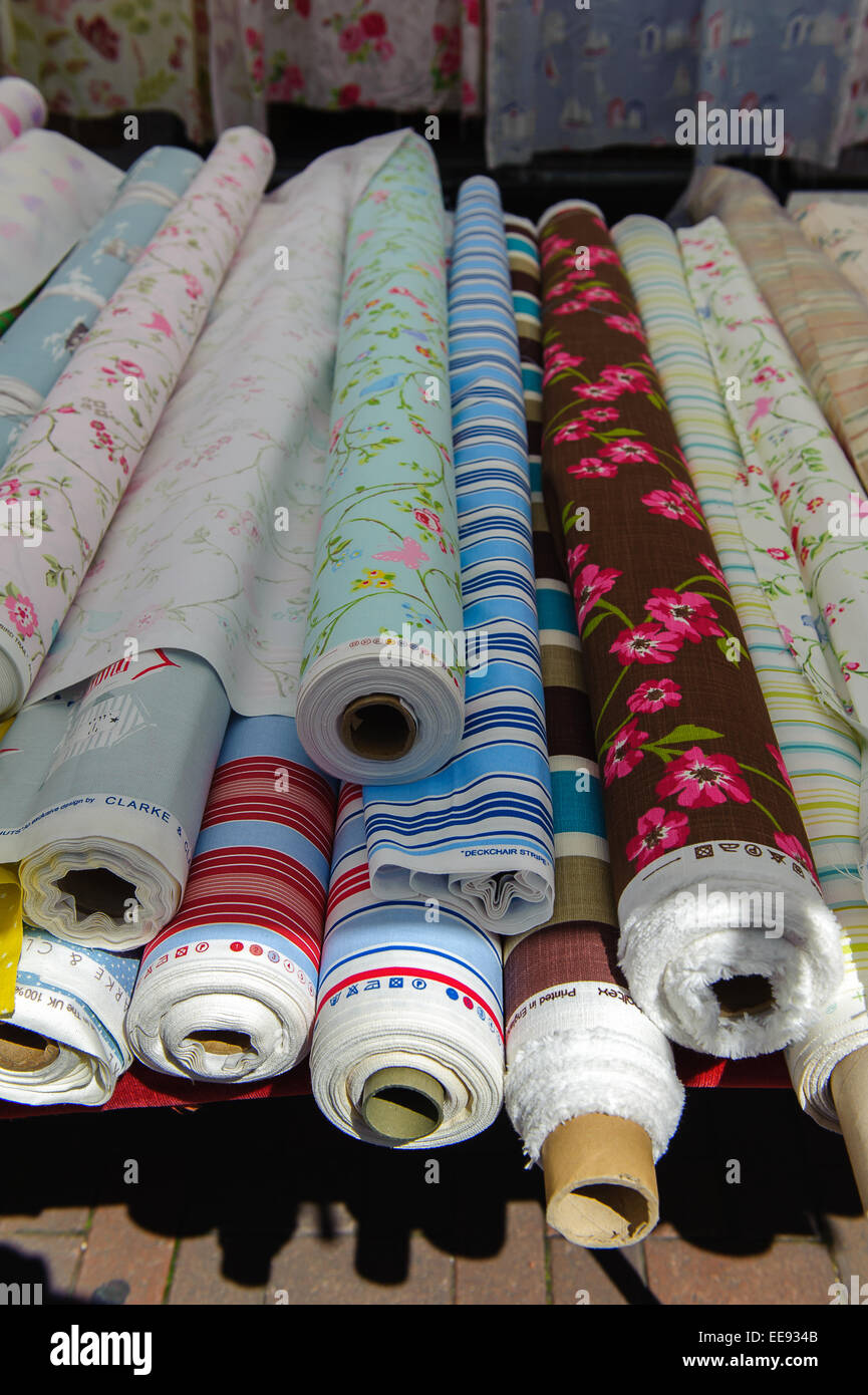 Market stall with rolls of cloth and coloured material hi-res stock ...