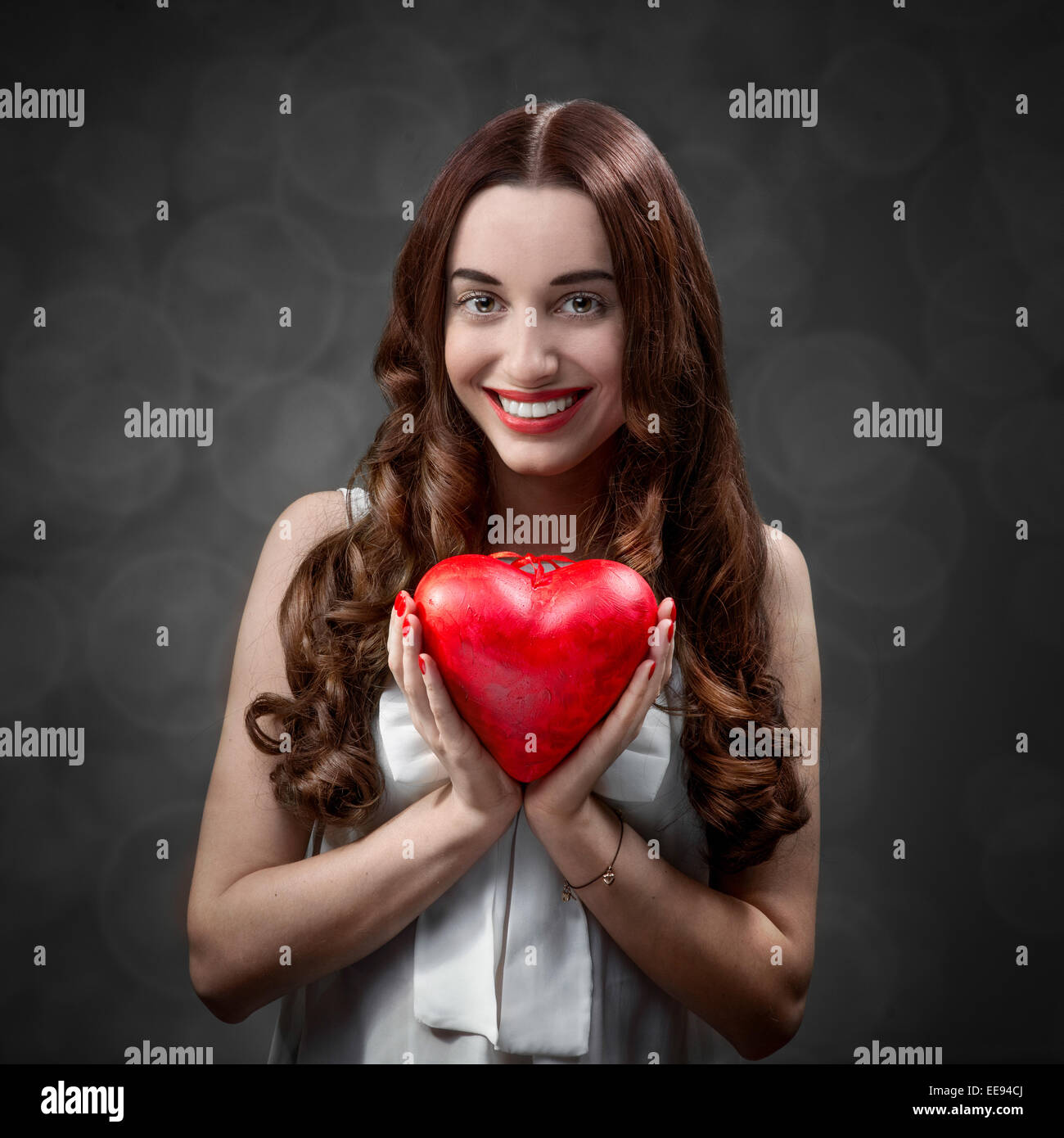 Woman with red heart Stock Photo - Alamy