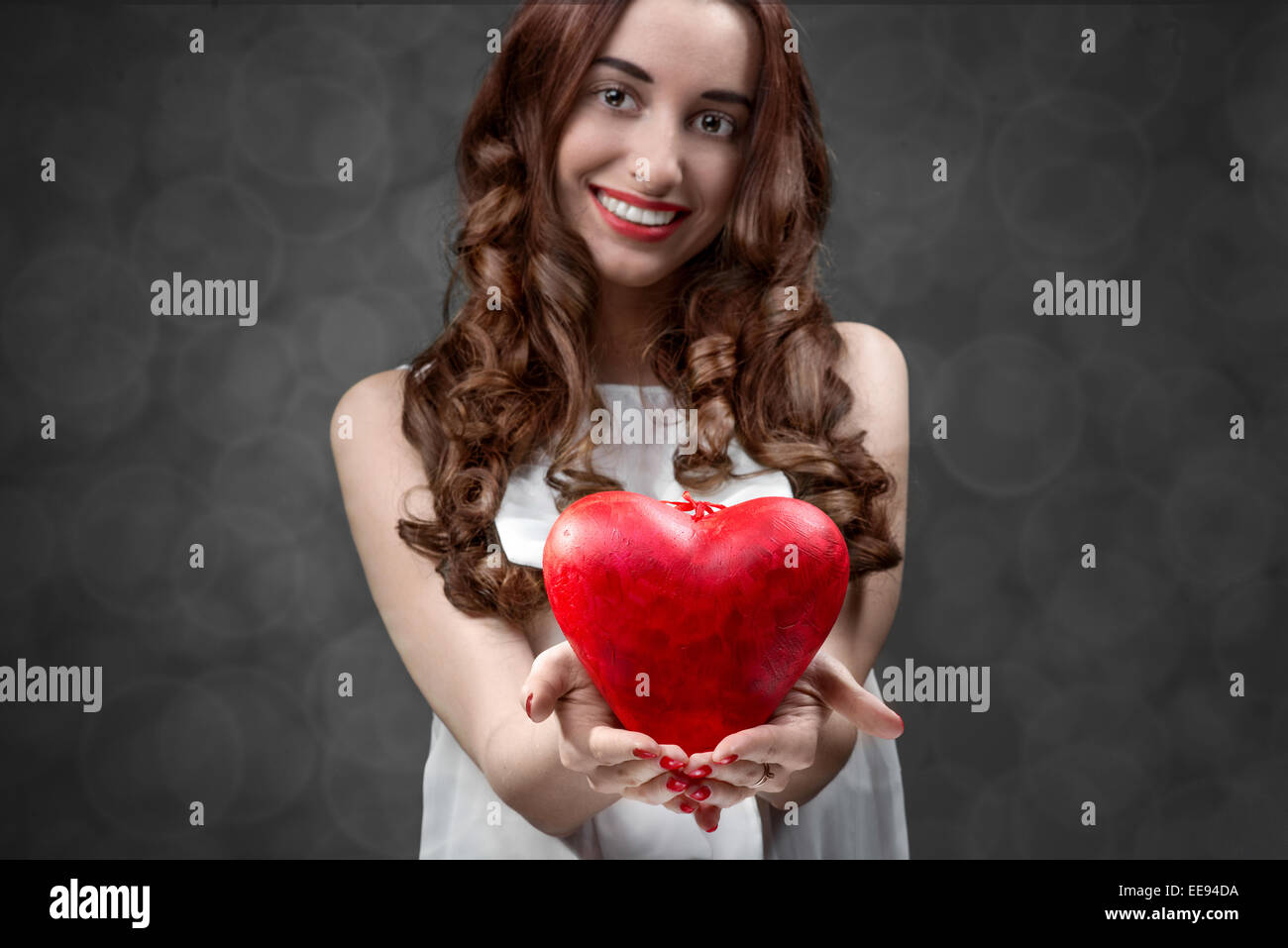 Woman with red heart Stock Photo - Alamy