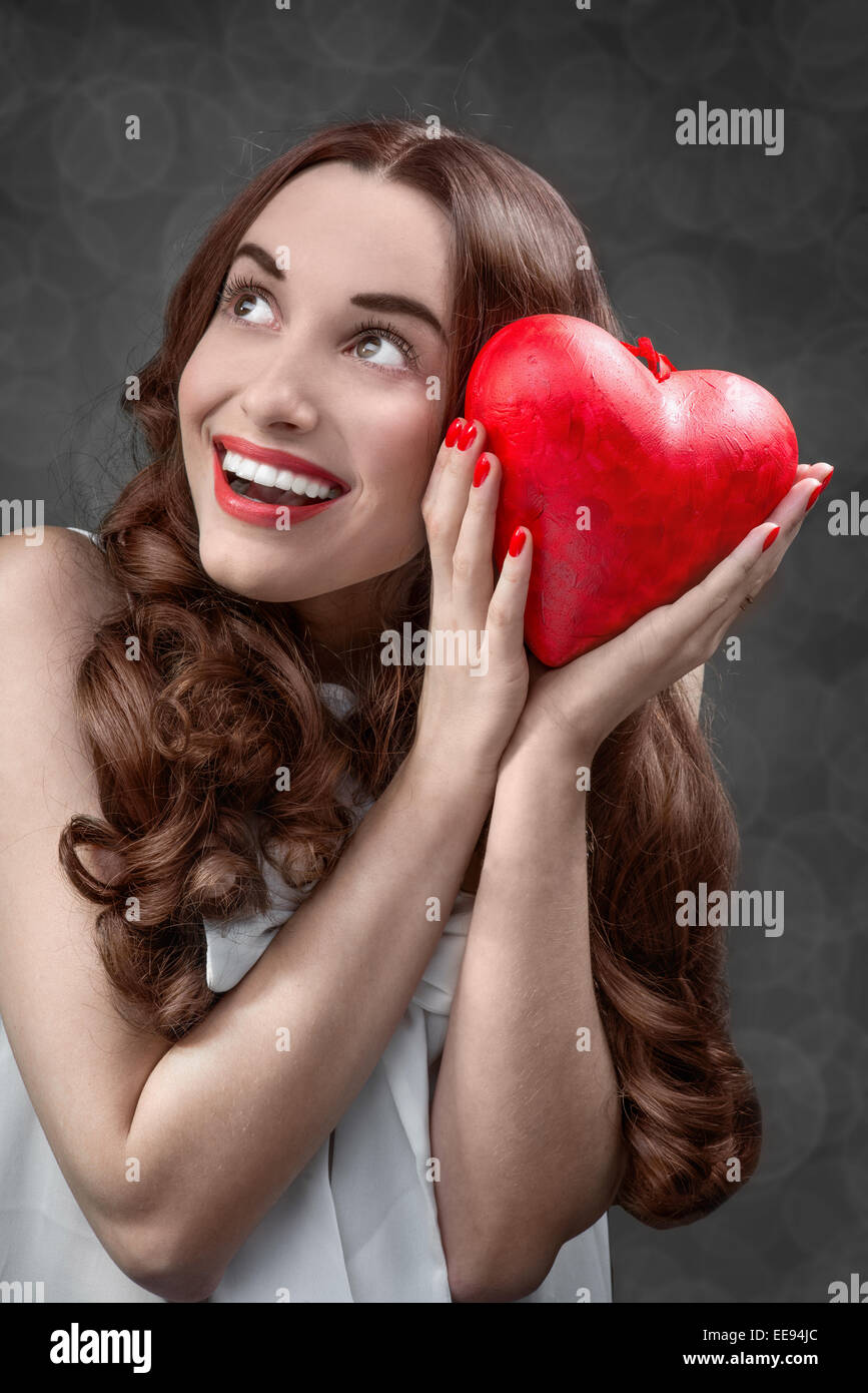 Woman with red heart Stock Photo - Alamy