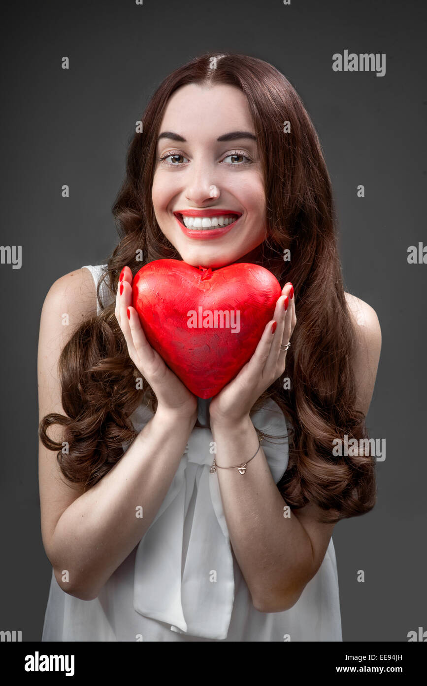 Woman with red heart Stock Photo - Alamy