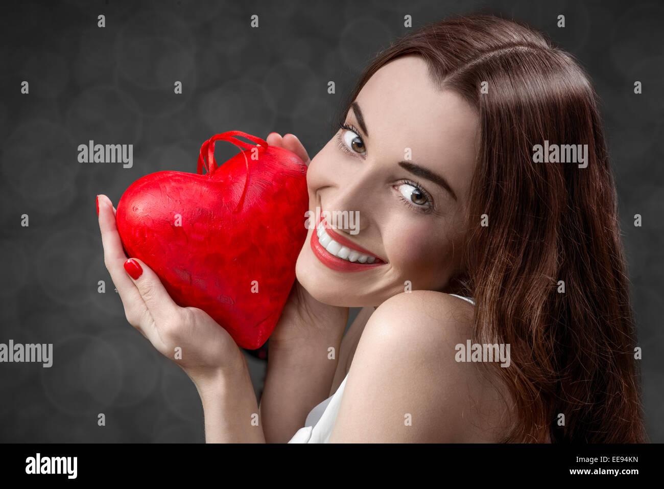 Woman with red heart Stock Photo - Alamy