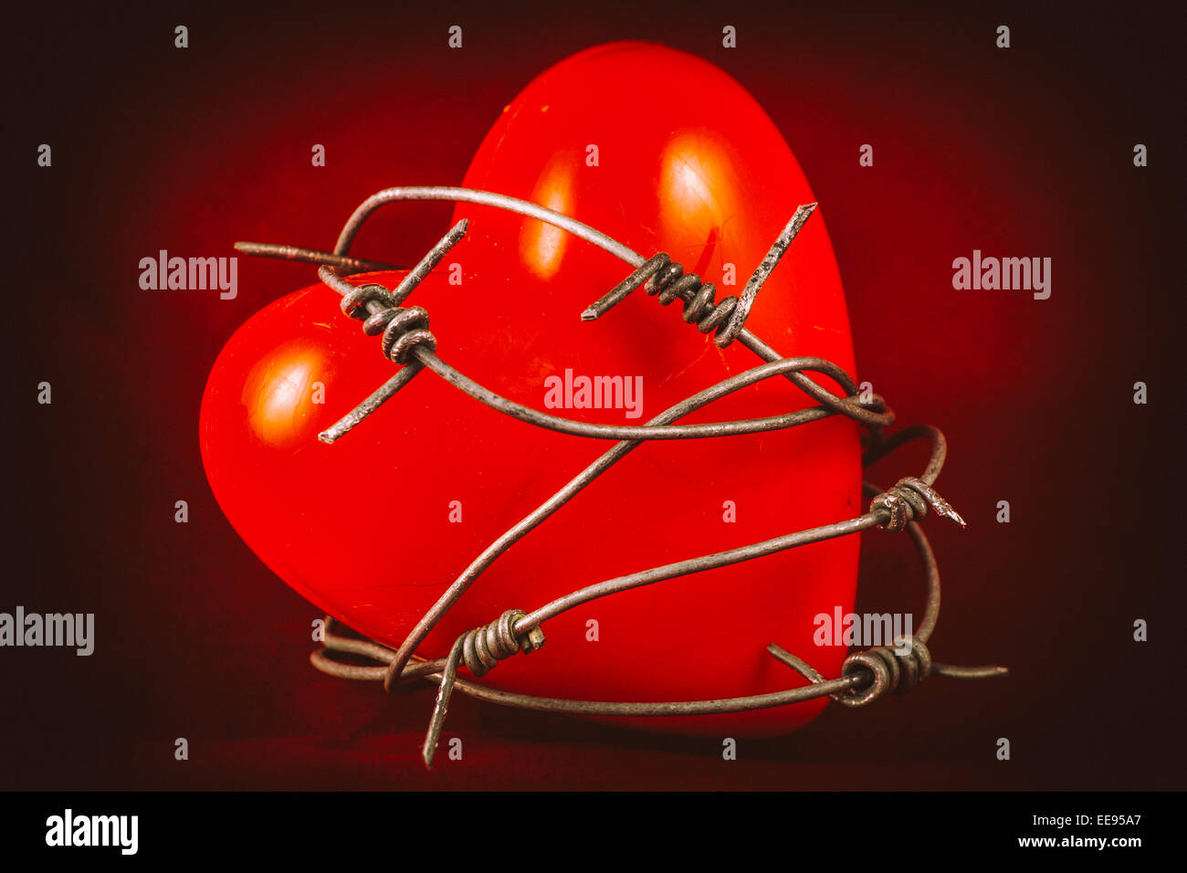 Heart in Barbed Wire on Red 1 Stock Photo - Alamy