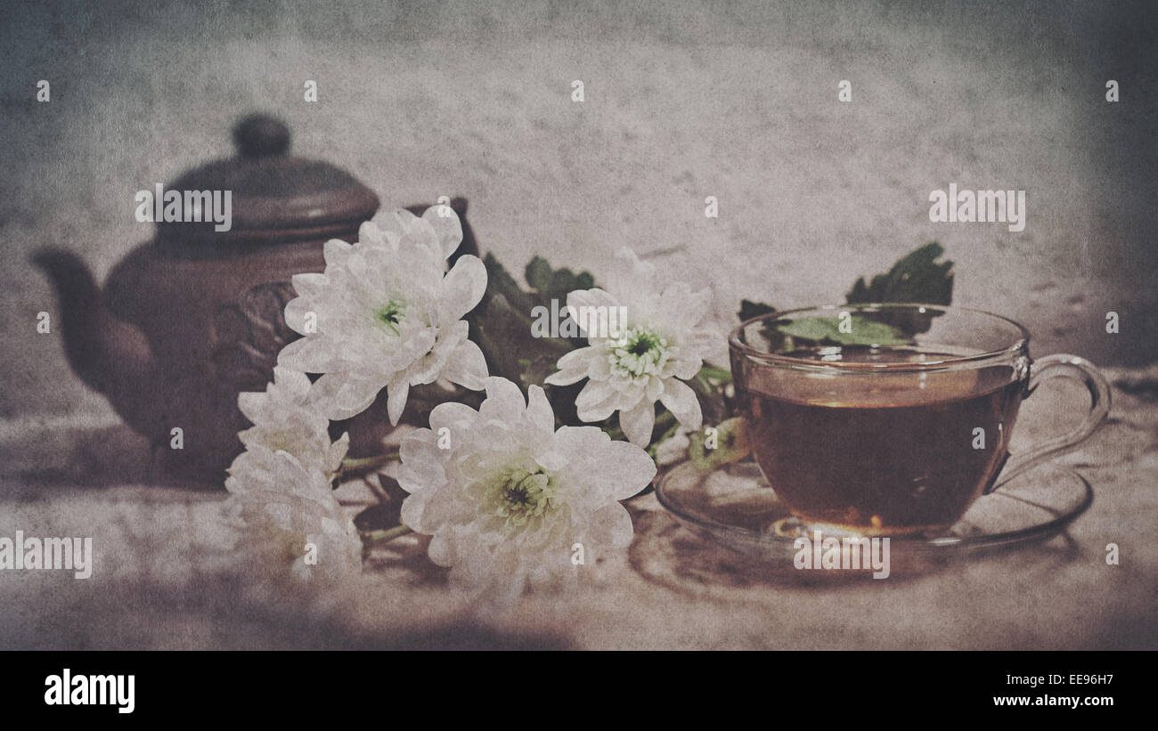 Grungy still life. Tea cup and pot on the wooden desk Stock Photo - Alamy