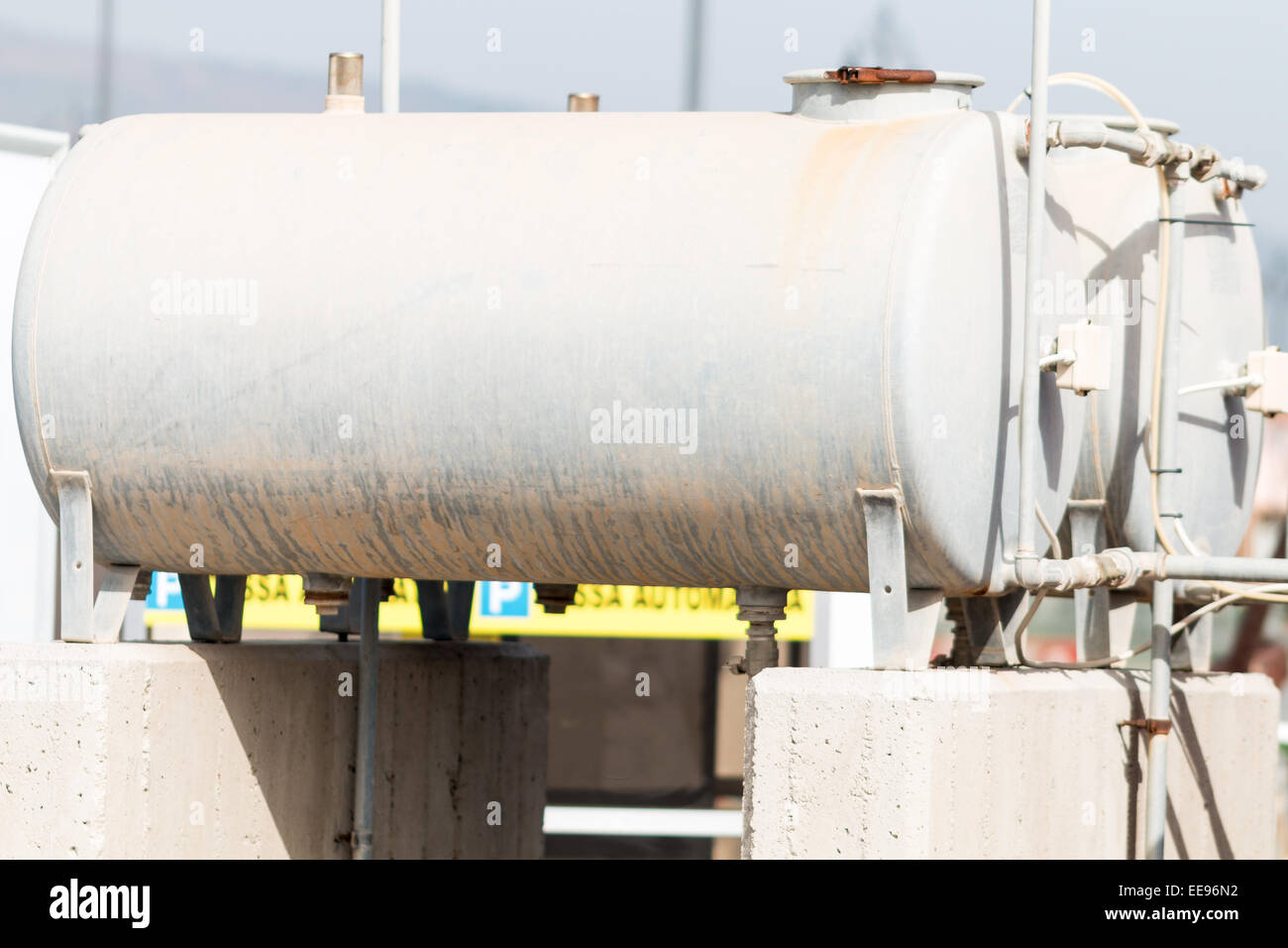 Water tank off the ground on concrete supports Stock Photo - Alamy
