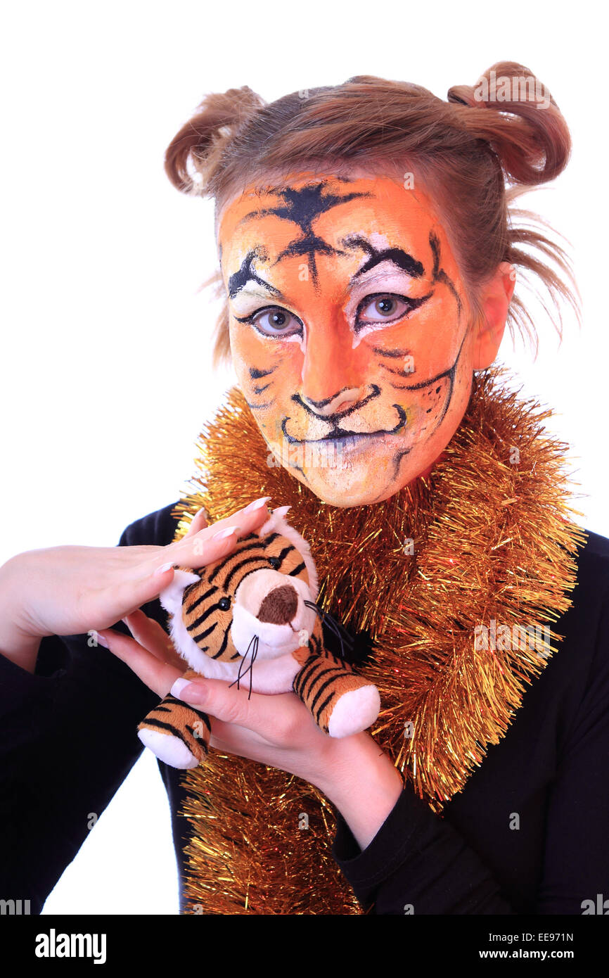 Girl in appearance a tiger with a toy tiger cub Stock Photo - Alamy