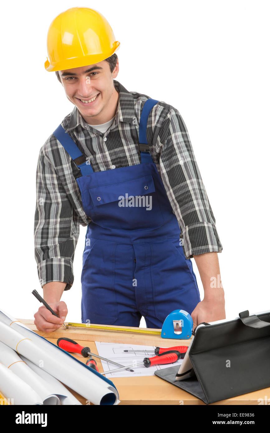 a worker measuring a board with a tape measure Stock Photo - Alamy