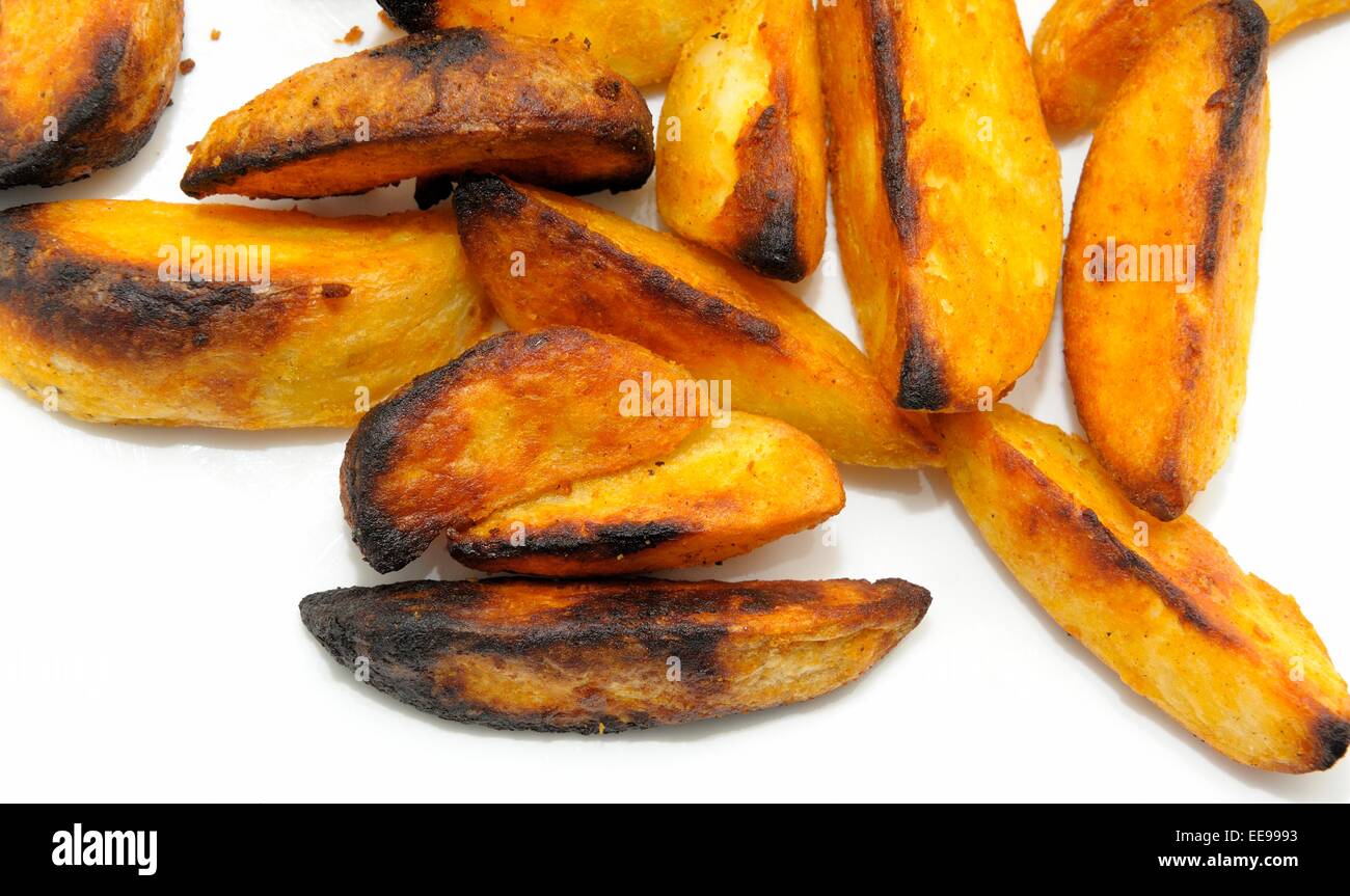 Burnt Potato wedges on a white background Stock Photo - Alamy