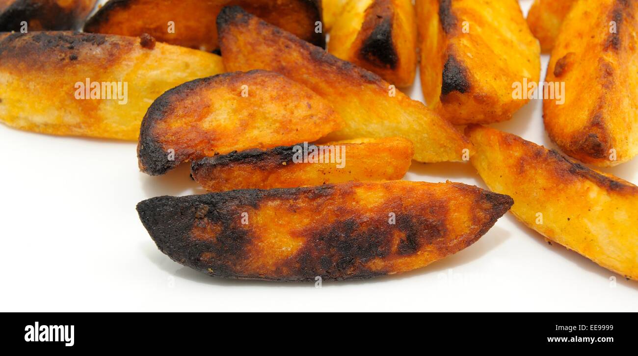 Burnt Potato wedges on a white background Stock Photo - Alamy