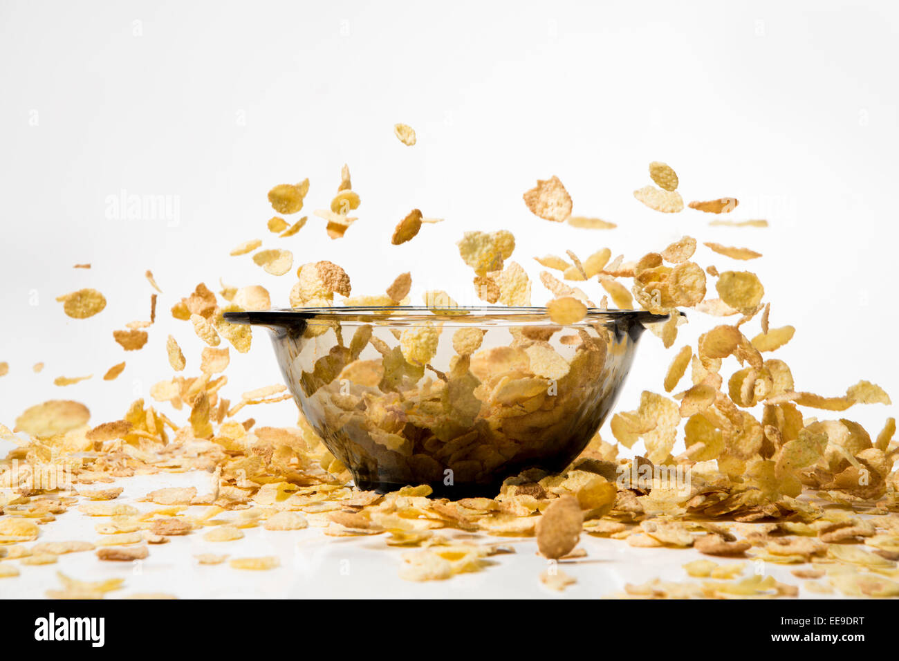 Cornflakes falling into a pile, over white background Stock Photo - Alamy
