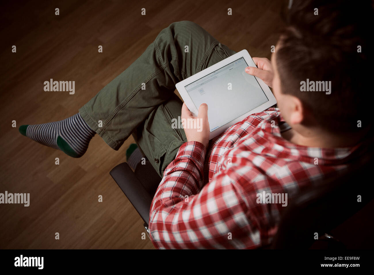 Adult man on tablet pc Stock Photo - Alamy