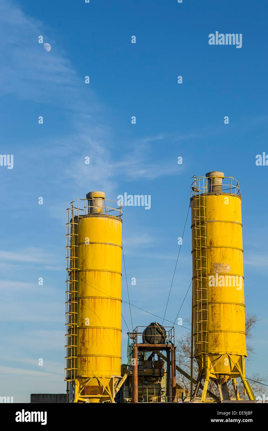 Two yellow reservoirs for gravel storage at a quarry Stock Photo - Alamy