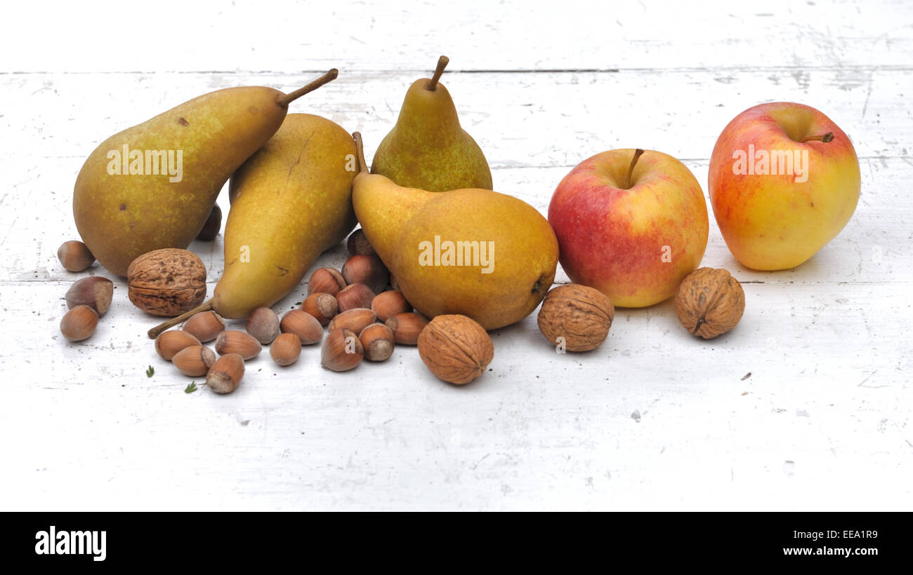 pears,apples and dried nuts on white table Stock Photo - Alamy