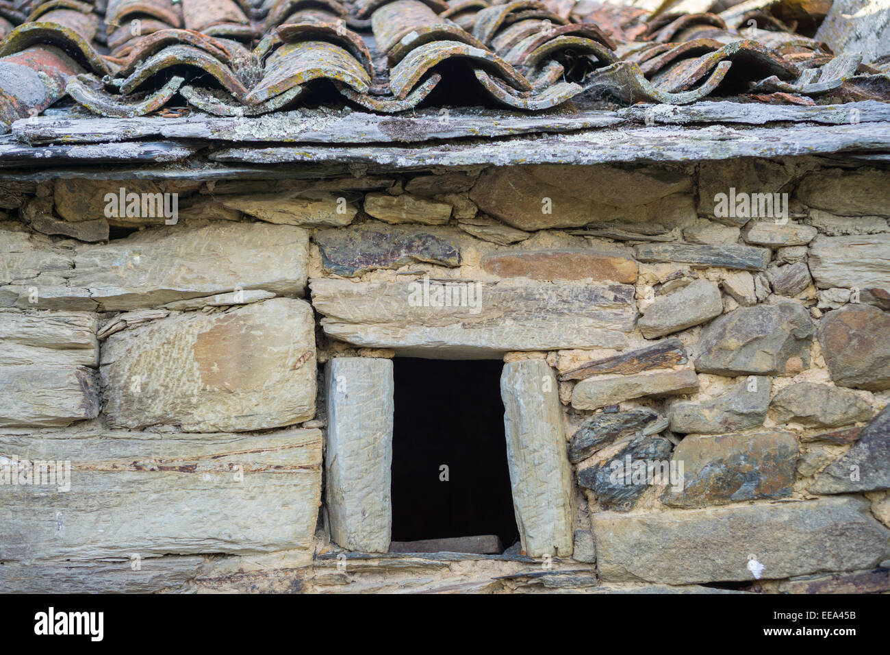 Old stone window, slate roof and stone wall Stock Photo - Alamy