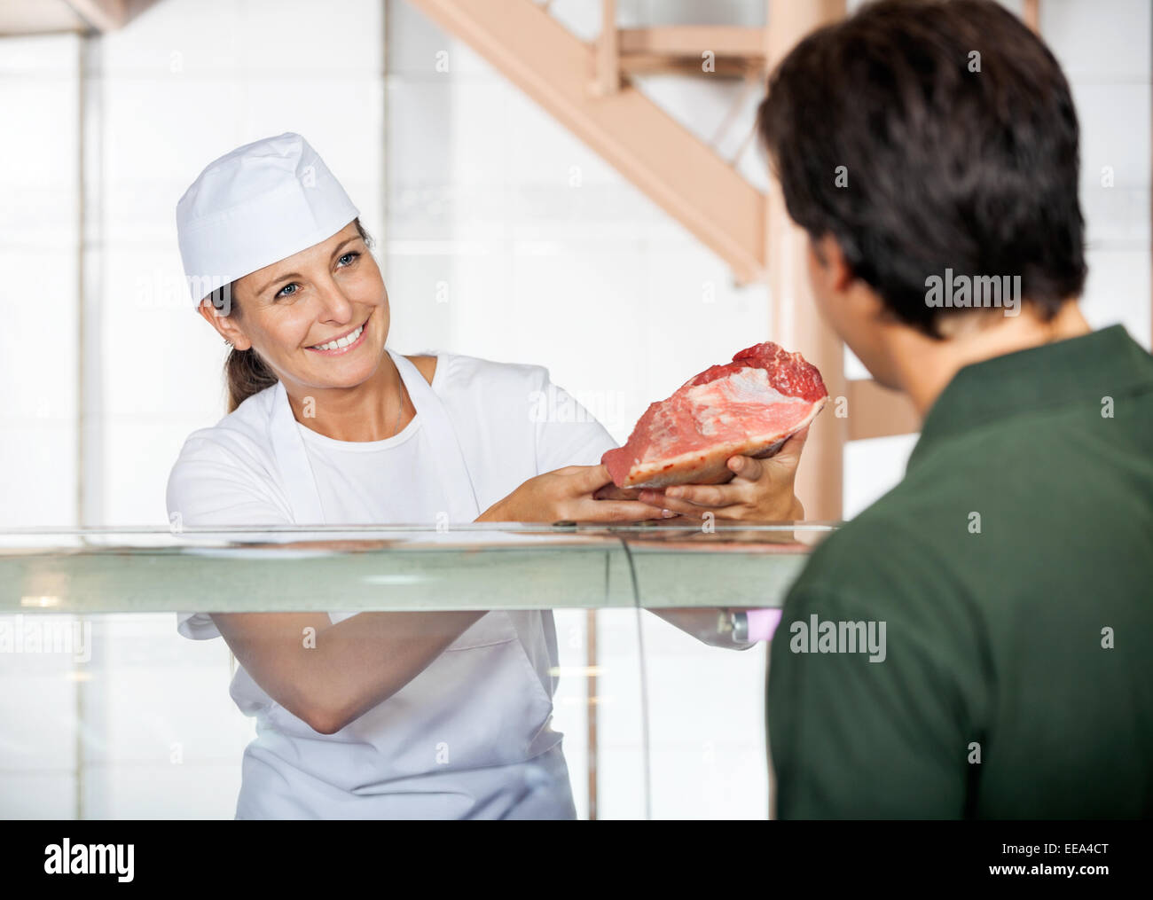 Butcher Selling Fresh Meat To Customer Stock Photo - Alamy