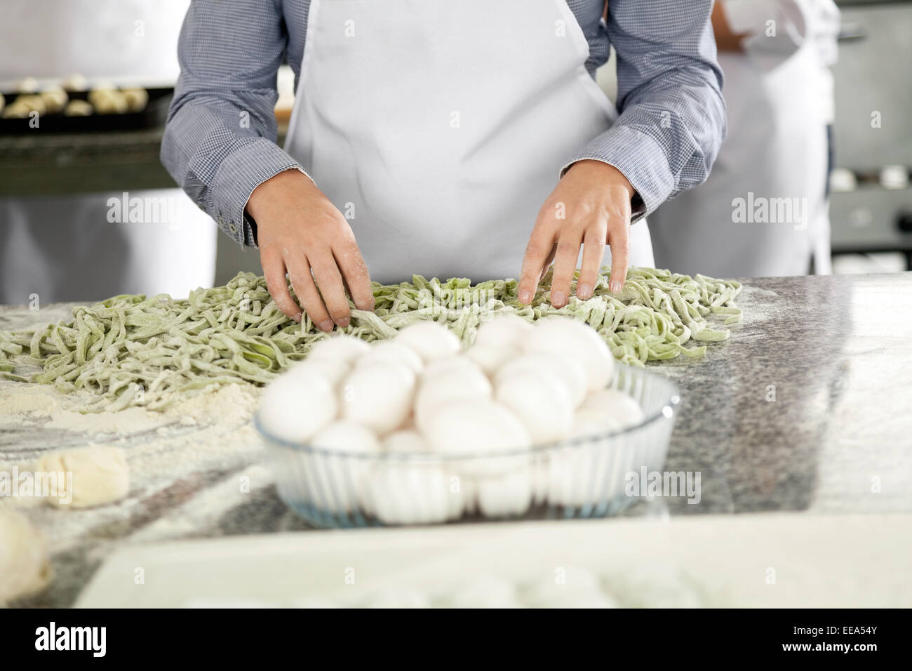 Chef At Counter With Spaghetti Pasta And Egg Bowl Stock Photo - Alamy
