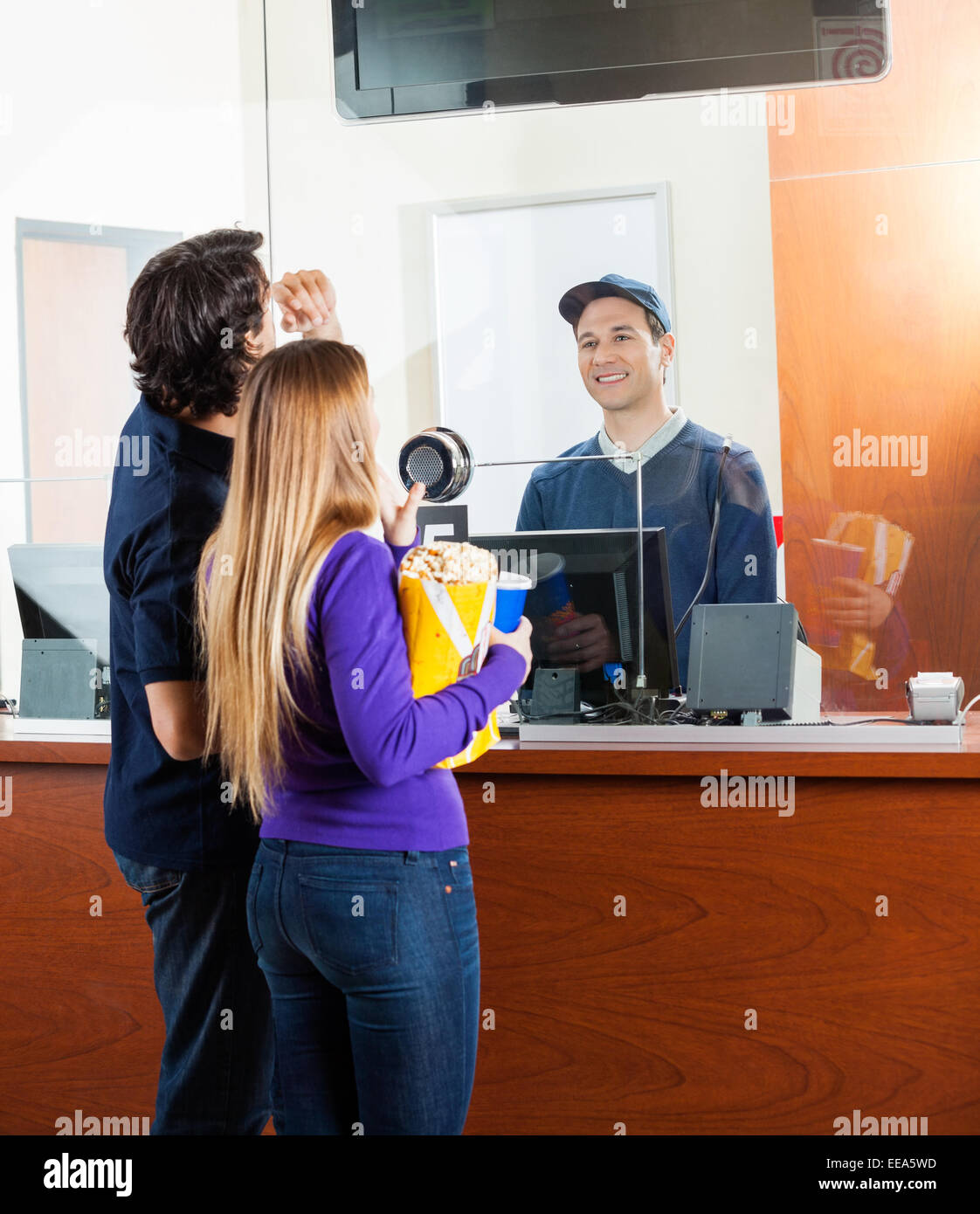 Couple Checking Movie Schedule At Box Office Stock Photo - Alamy