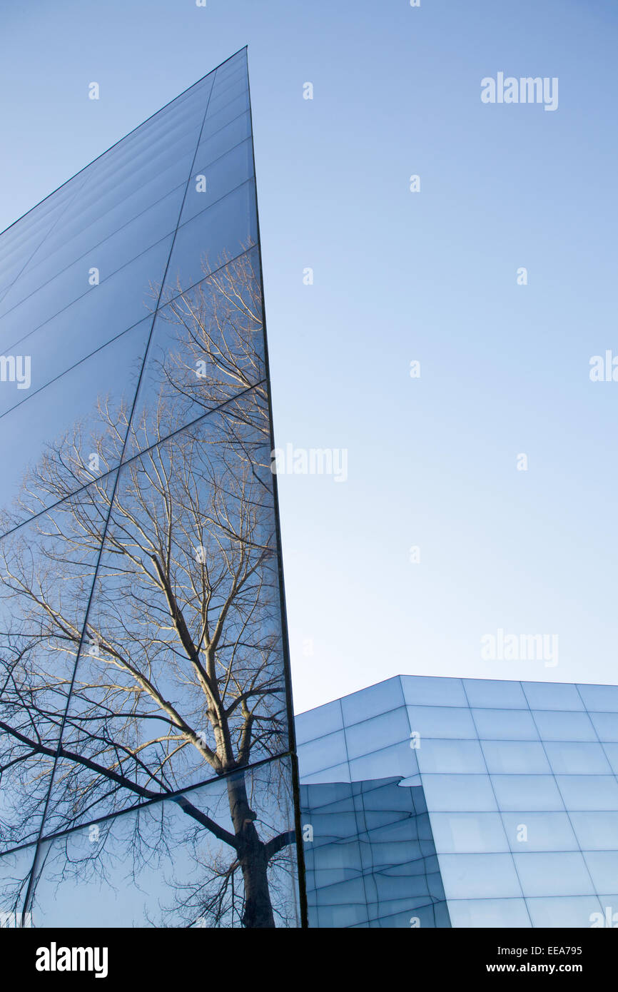 part of facades of geometrically shaped modern glass building with ...