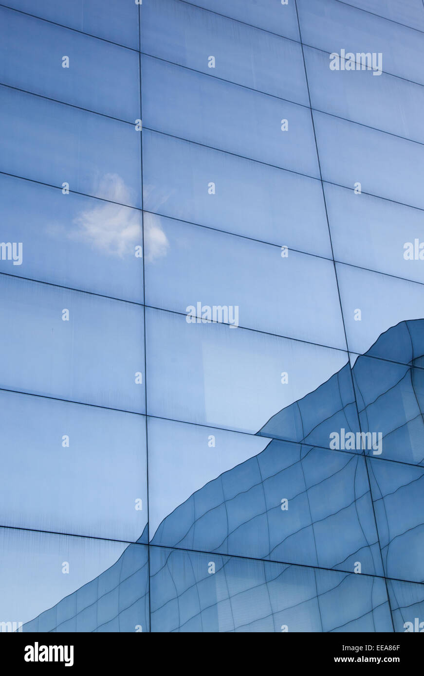 part of facade of geometrically shaped modern glass building with ...