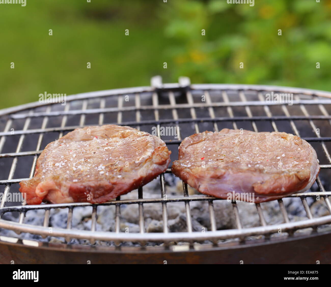 beef steak grilled on a barbecue outdoors Stock Photo - Alamy