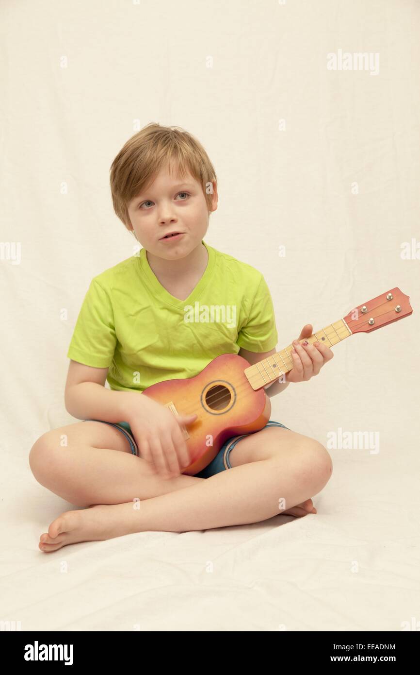 young boy playing ukulele Stock Photo - Alamy