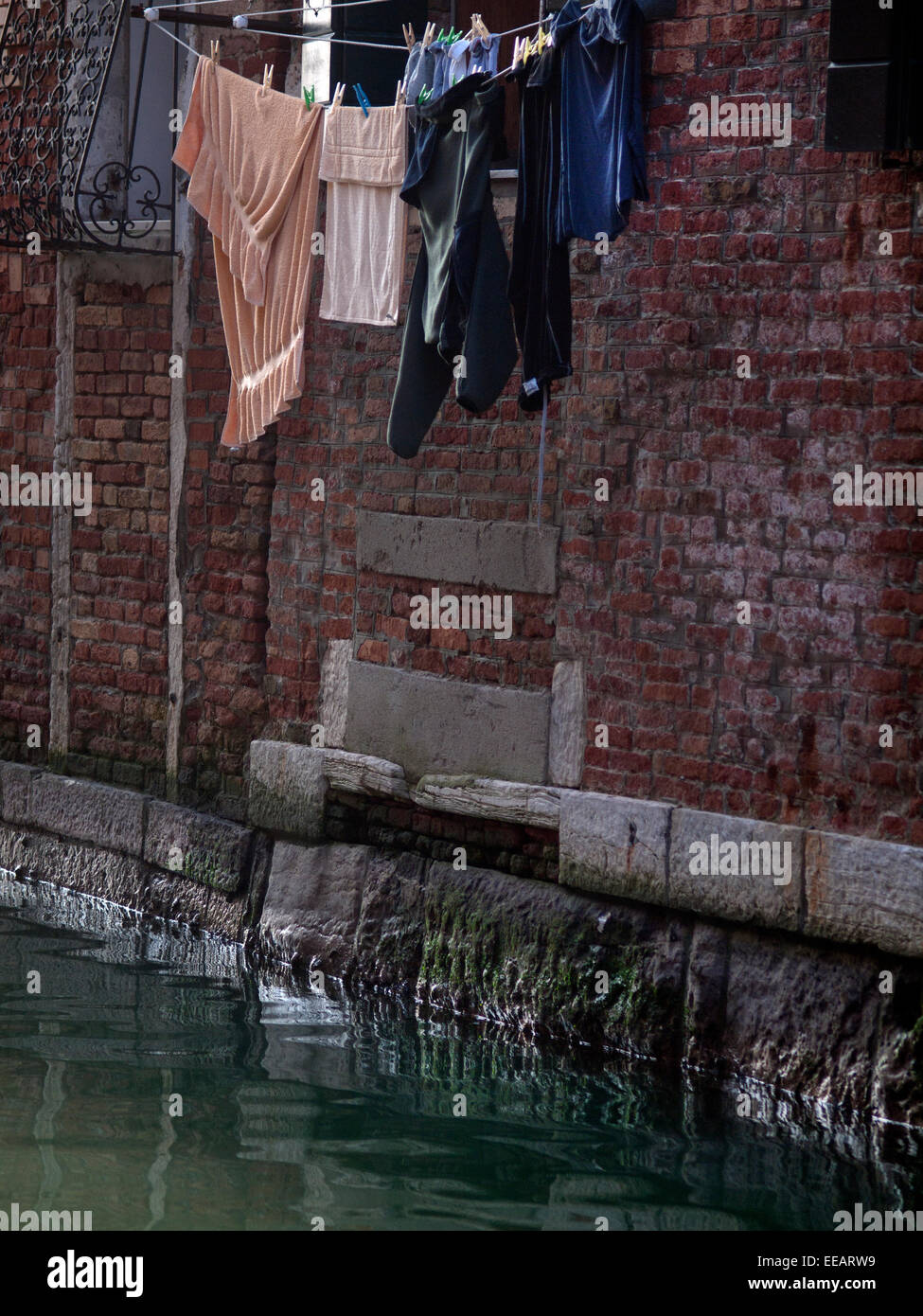 Washing hung out to dry above a canal in Venice Stock Photo - Alamy