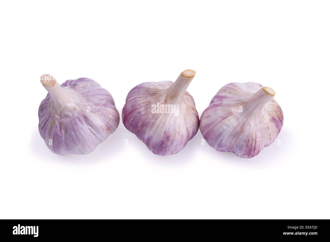 Three garlic heads isolated on white background Stock Photo - Alamy