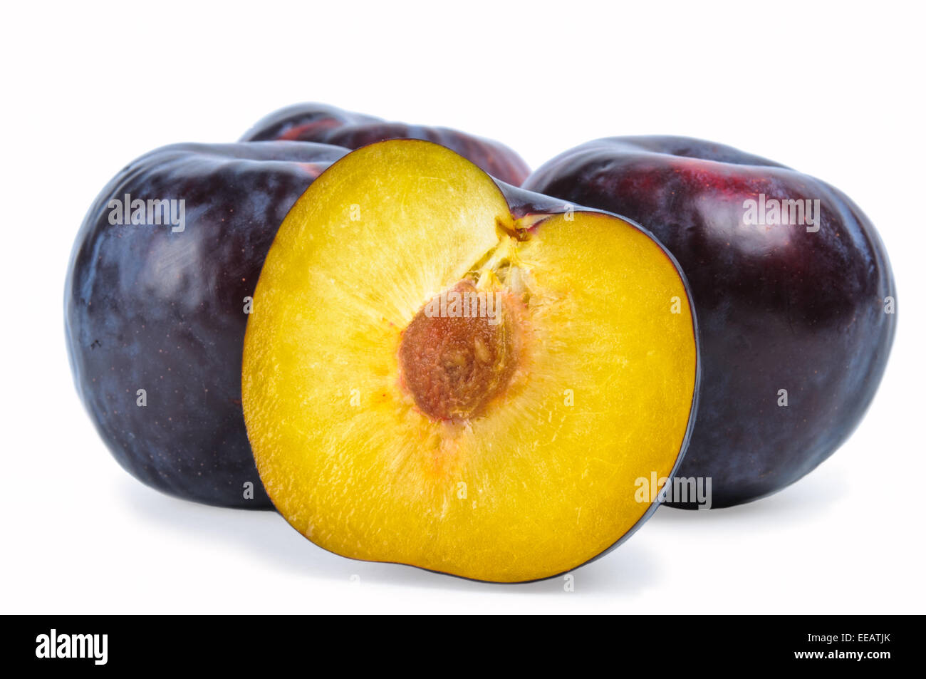 Four plum fruits isolated on white background Stock Photo - Alamy