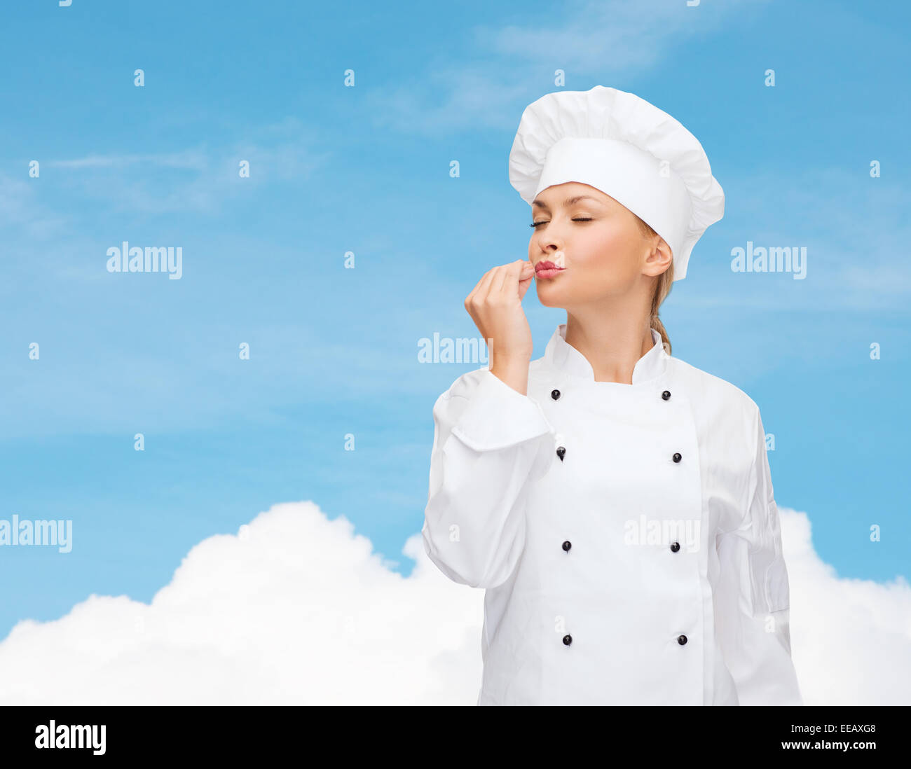 smiling female chef showing delicious sign Stock Photo - Alamy
