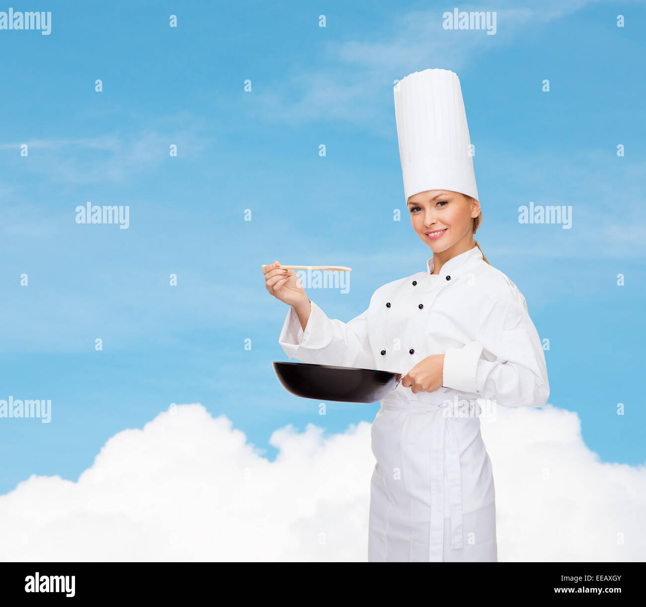 smiling female chef with pan and spoon Stock Photo - Alamy