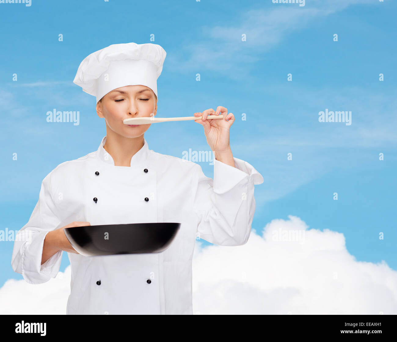 smiling female chef with pan and spoon Stock Photo - Alamy