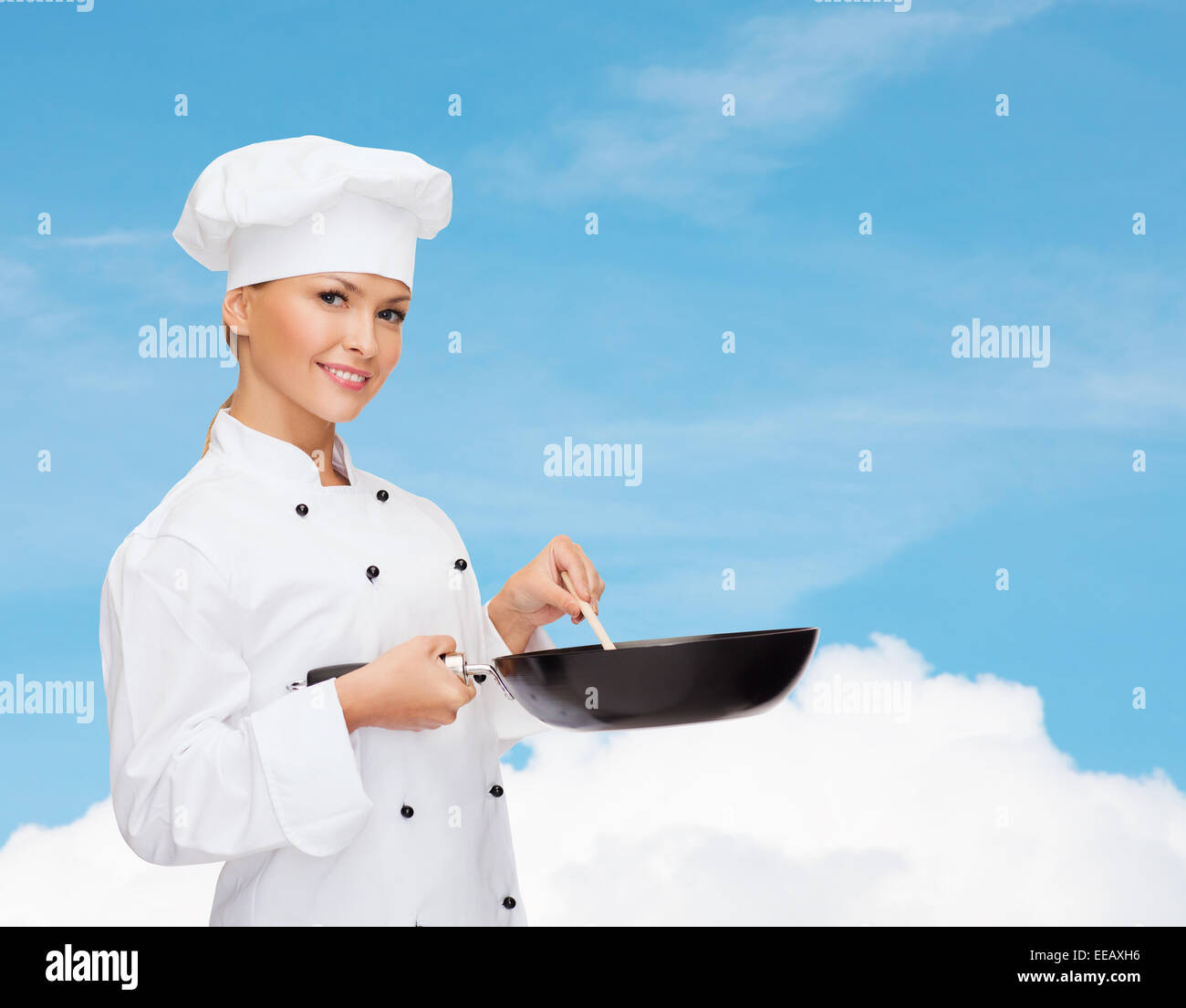 smiling female chef with pan and spoon Stock Photo - Alamy