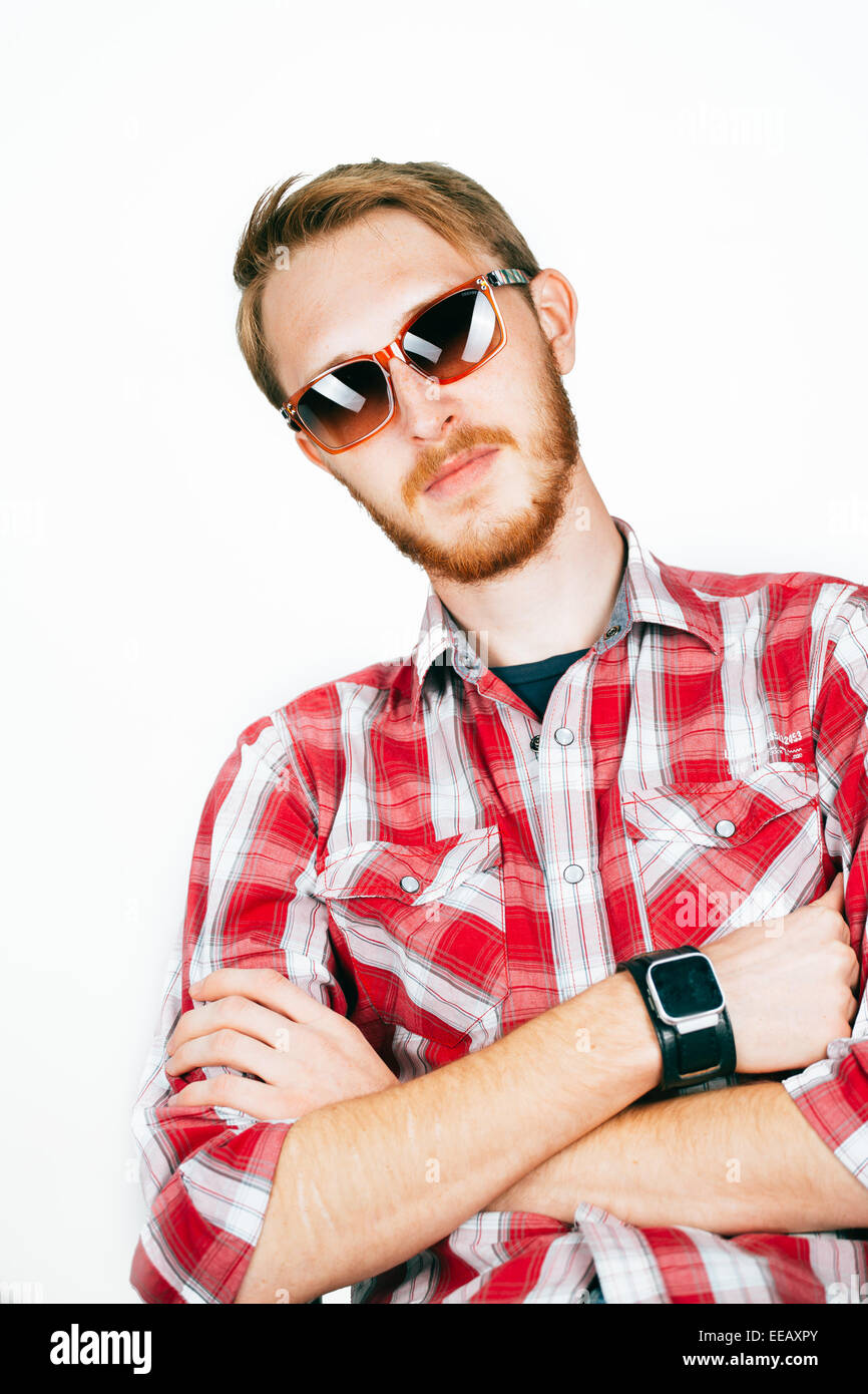 young casual man passing his hand through his hair while looking away ...