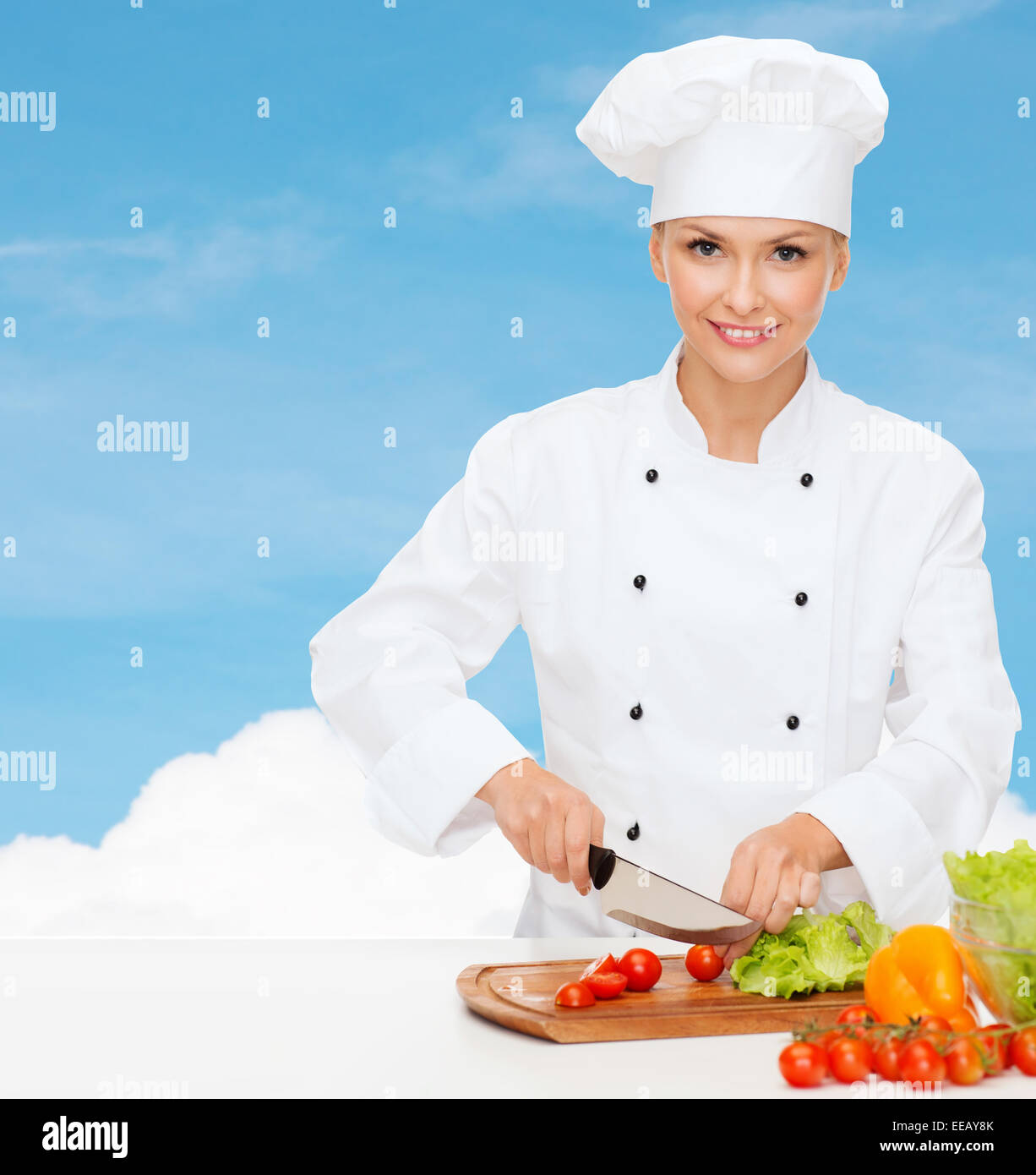 smiling female chef chopping vegetables Stock Photo - Alamy