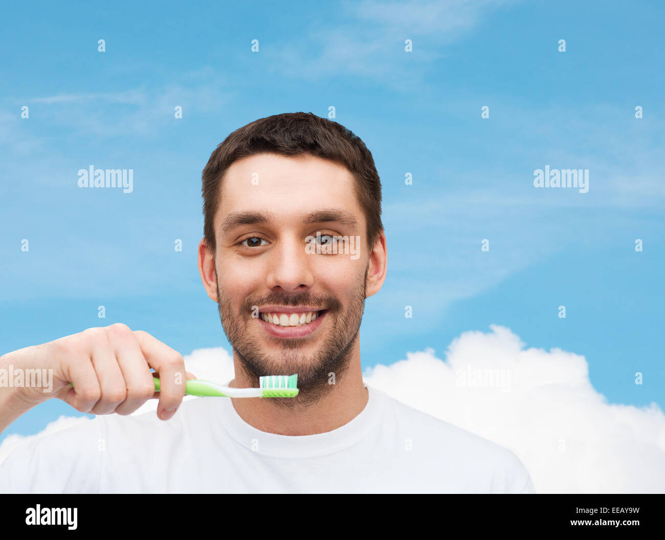 smiling young man with toothbrush Stock Photo - Alamy