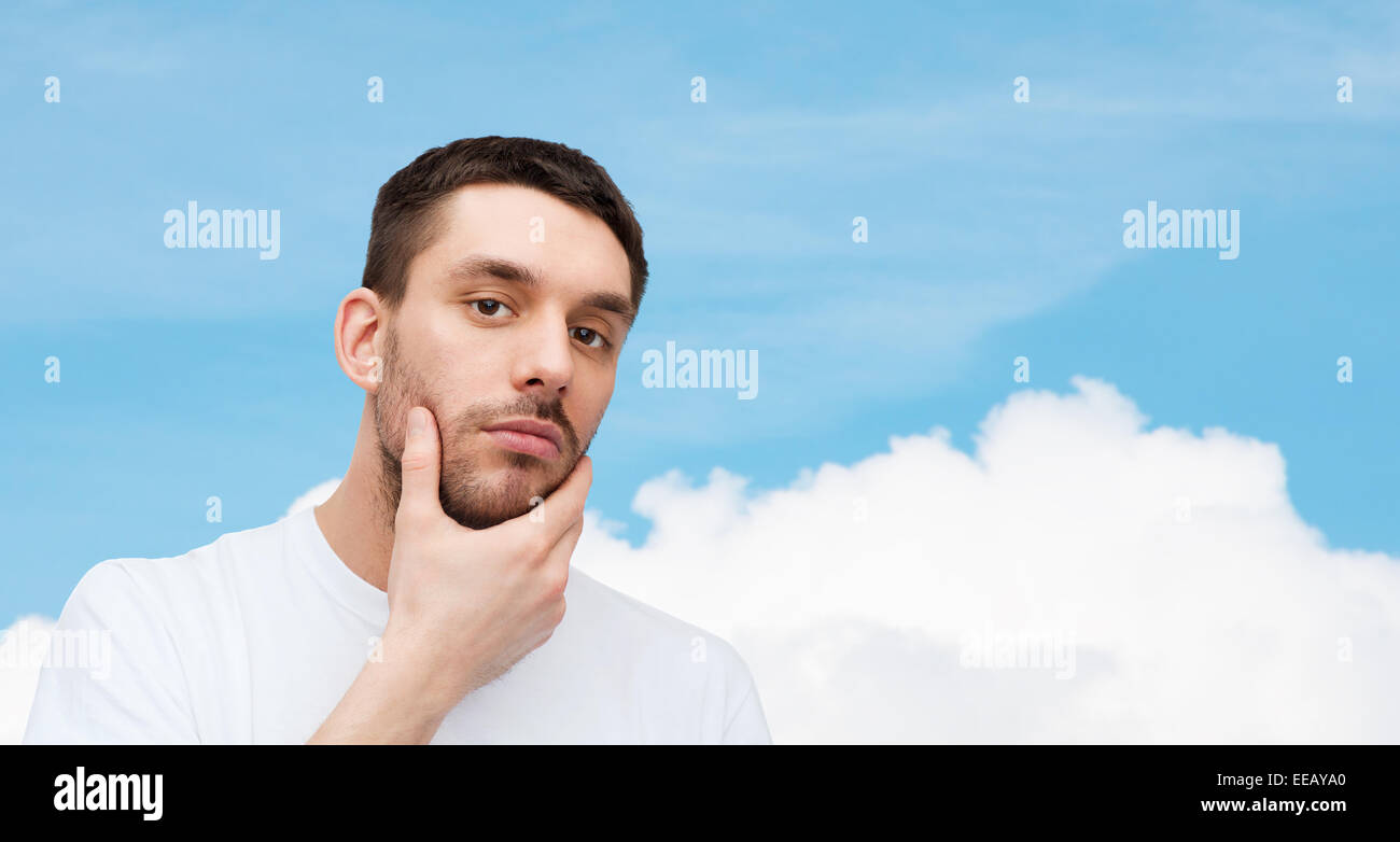 beautiful calm man touching his face Stock Photo - Alamy