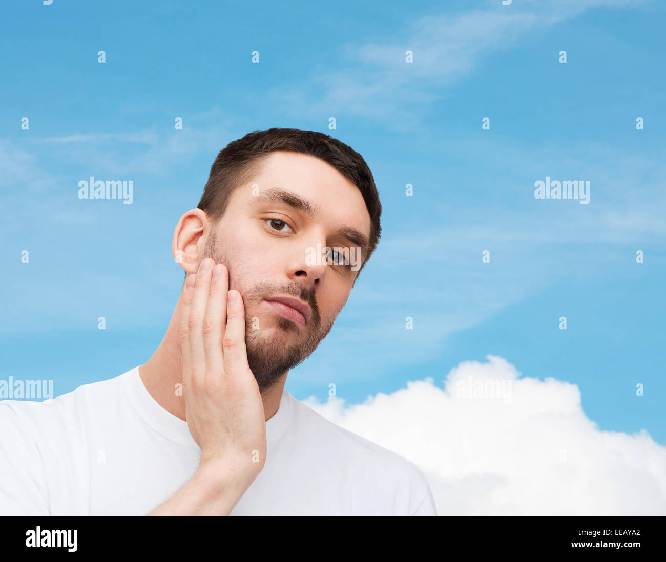 beautiful calm man touching his face Stock Photo - Alamy