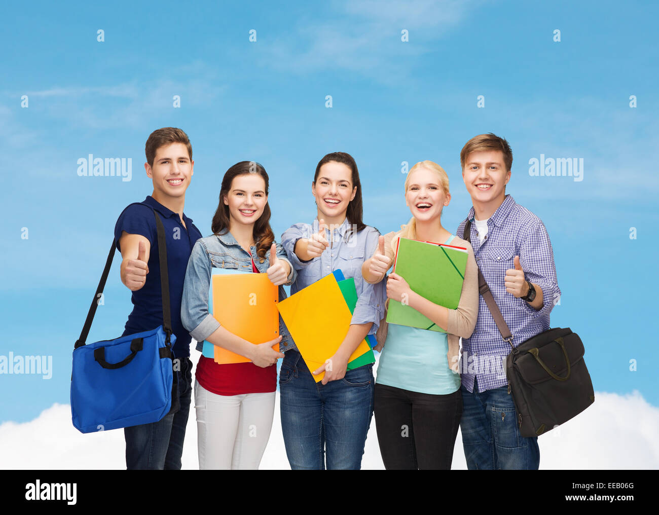 group of smiling students showing thumbs up Stock Photo - Alamy