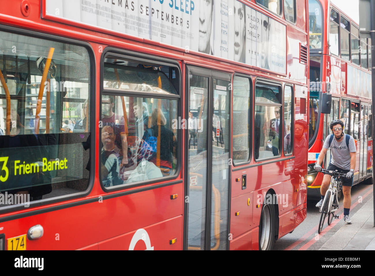 Cyclist cycling busy traffic bus hi-res stock photography and images - Alamy
