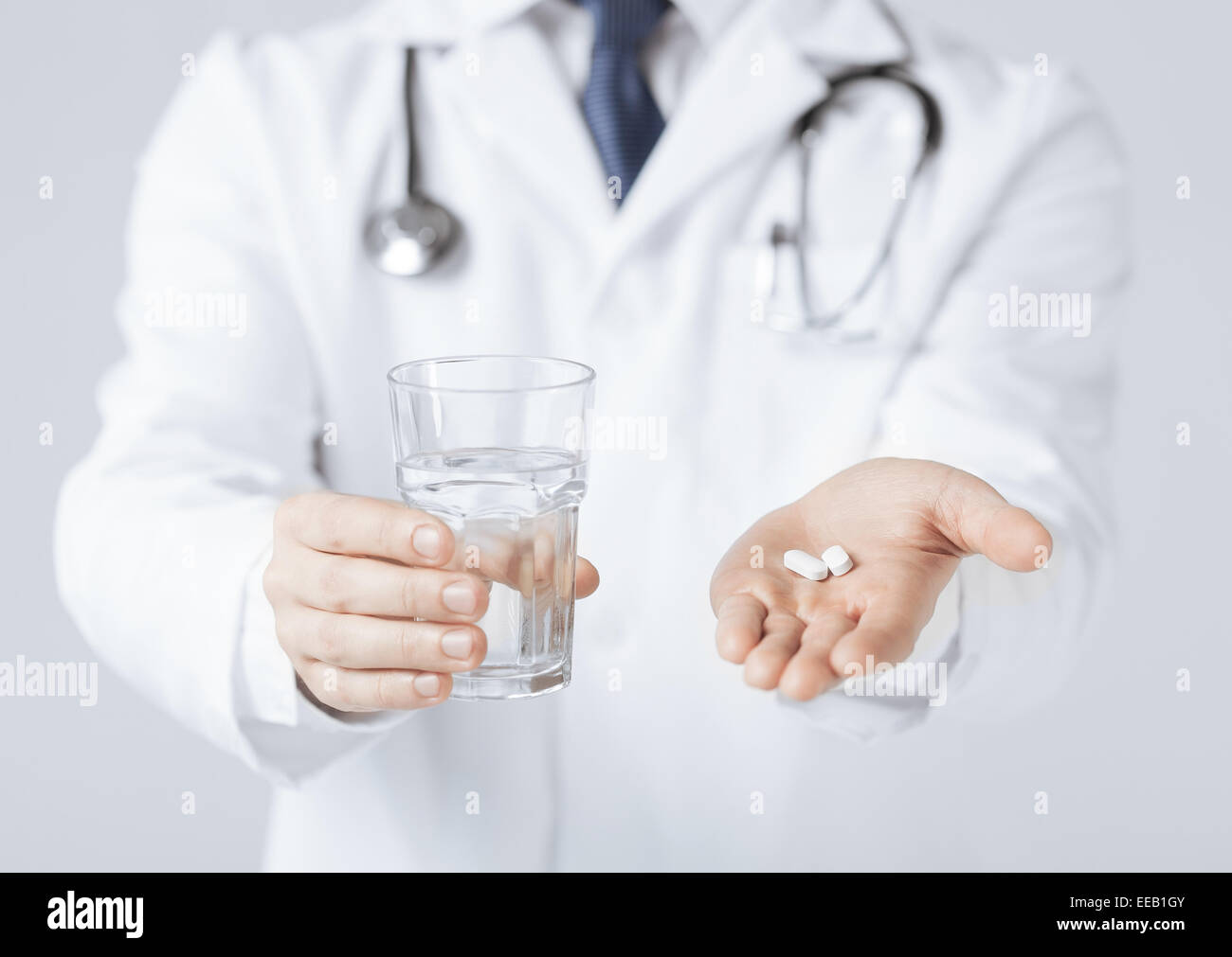 doctor hands giving white pills and glass of water Stock Photo - Alamy