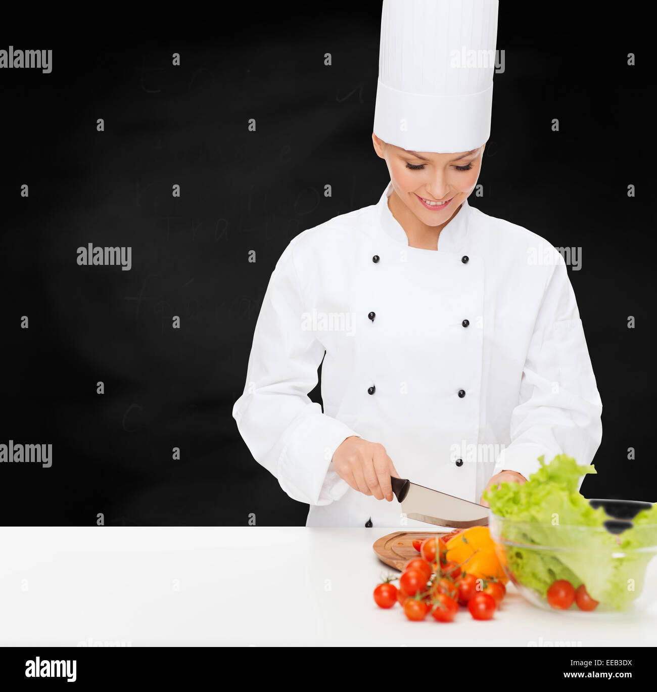 smiling female chef chopping vegetables Stock Photo - Alamy