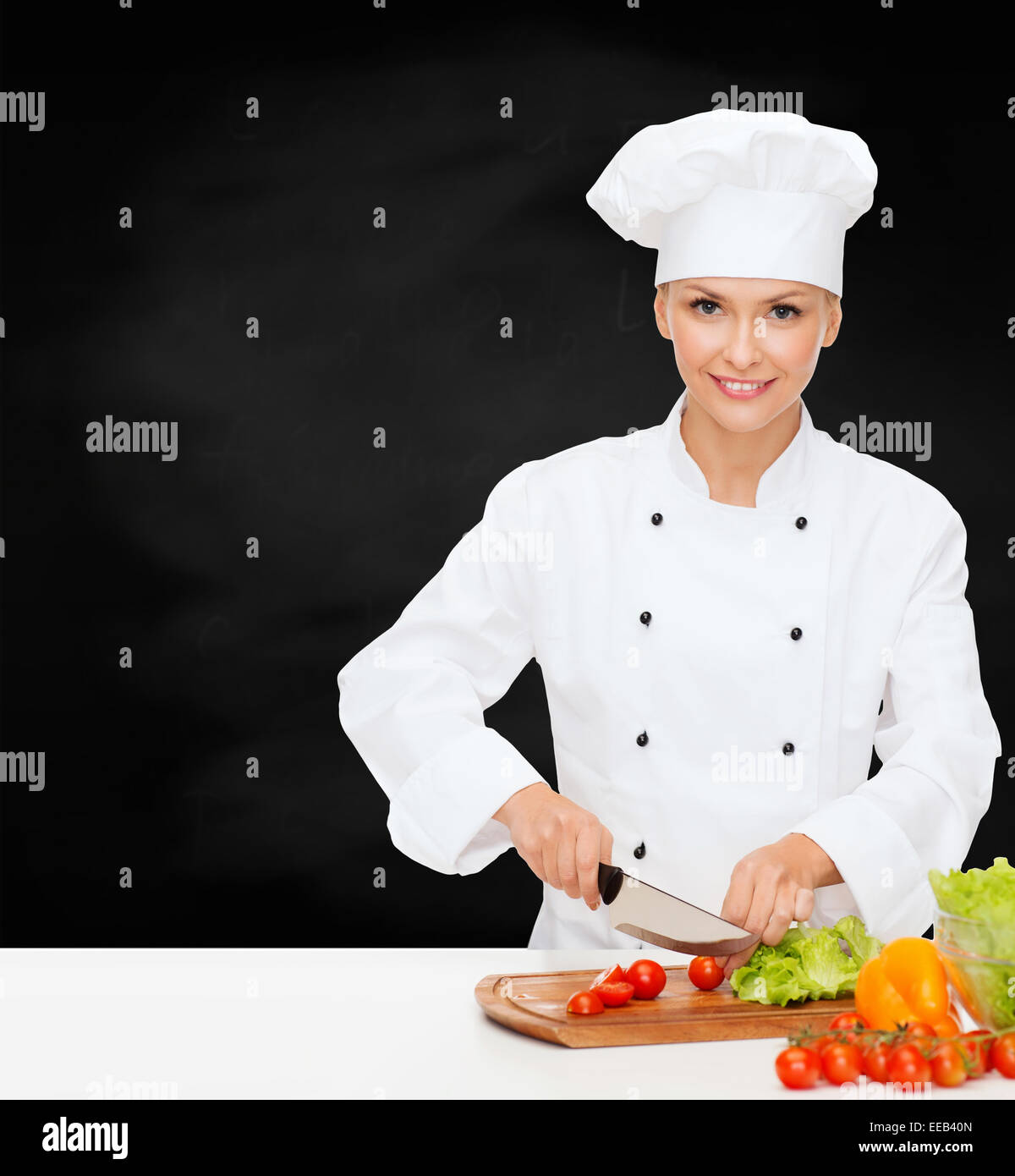 smiling female chef chopping vegetables Stock Photo - Alamy