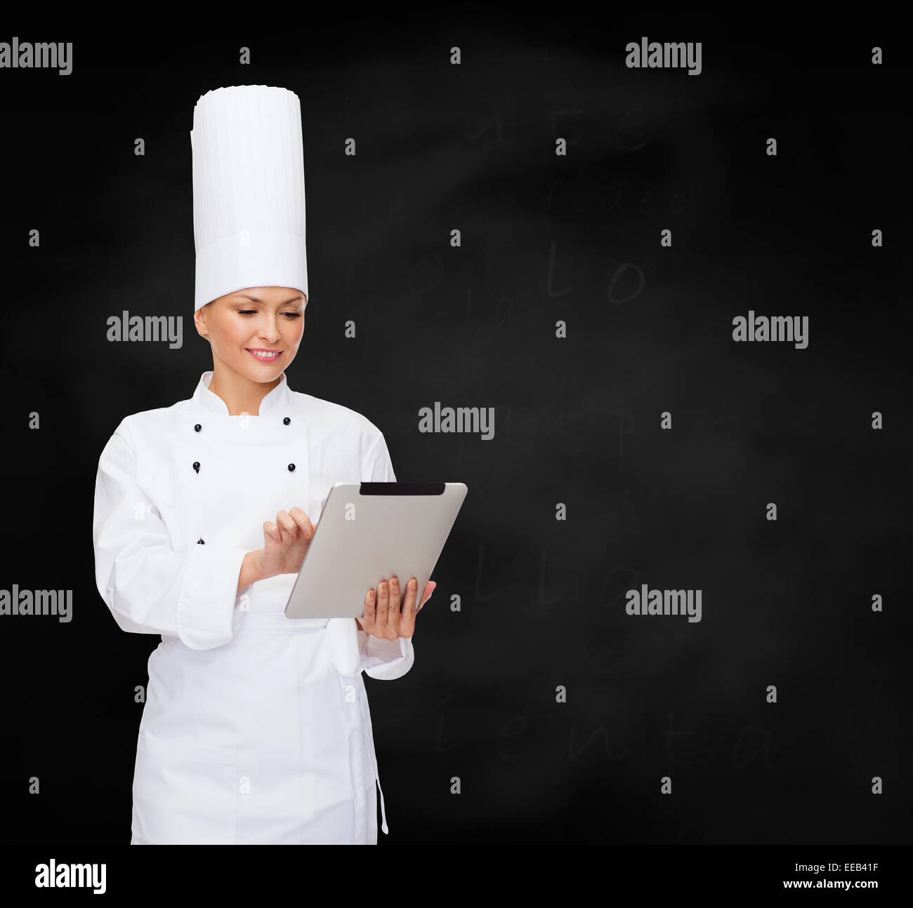 smiling female chef with tablet pc computer Stock Photo - Alamy