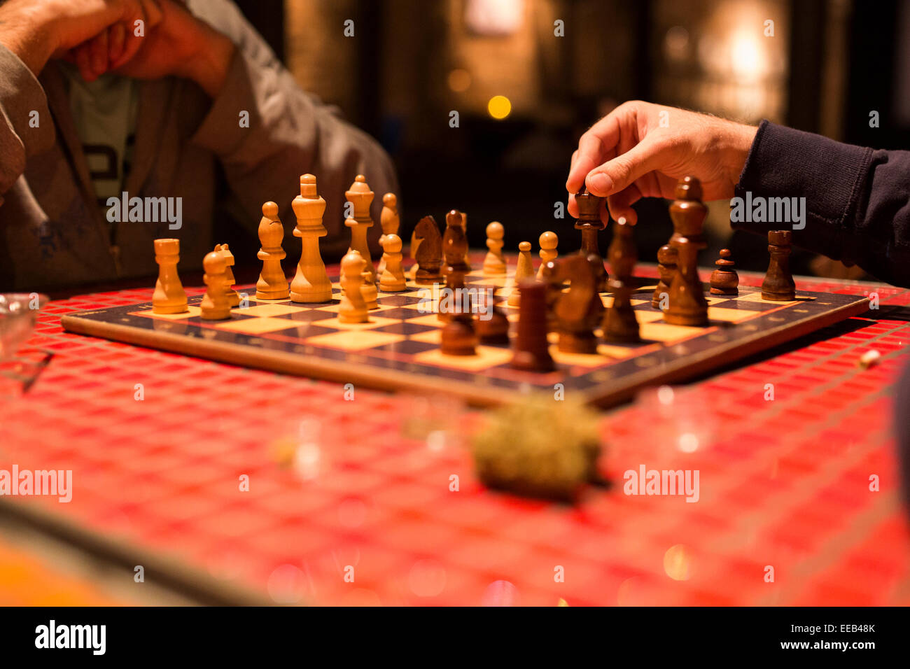 A marijuana bud lies on a table as customers play a round of chess at ...