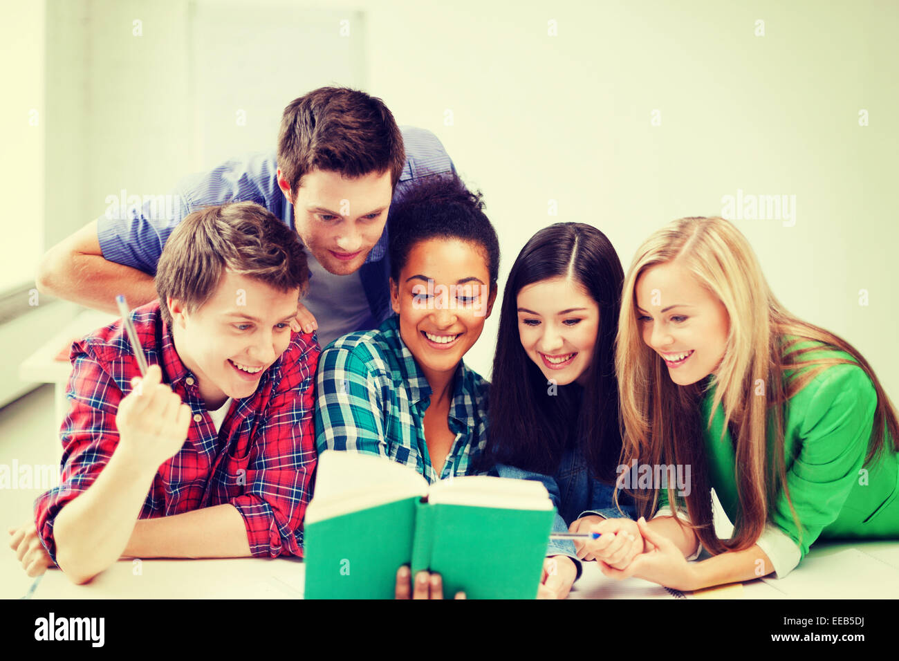 students reading book at school Stock Photo - Alamy