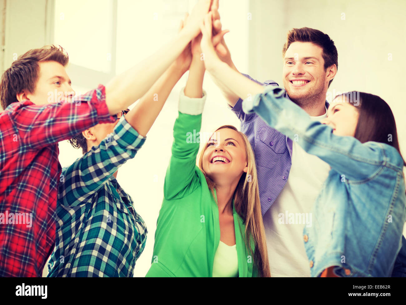happy students giving high five at school Stock Photo - Alamy
