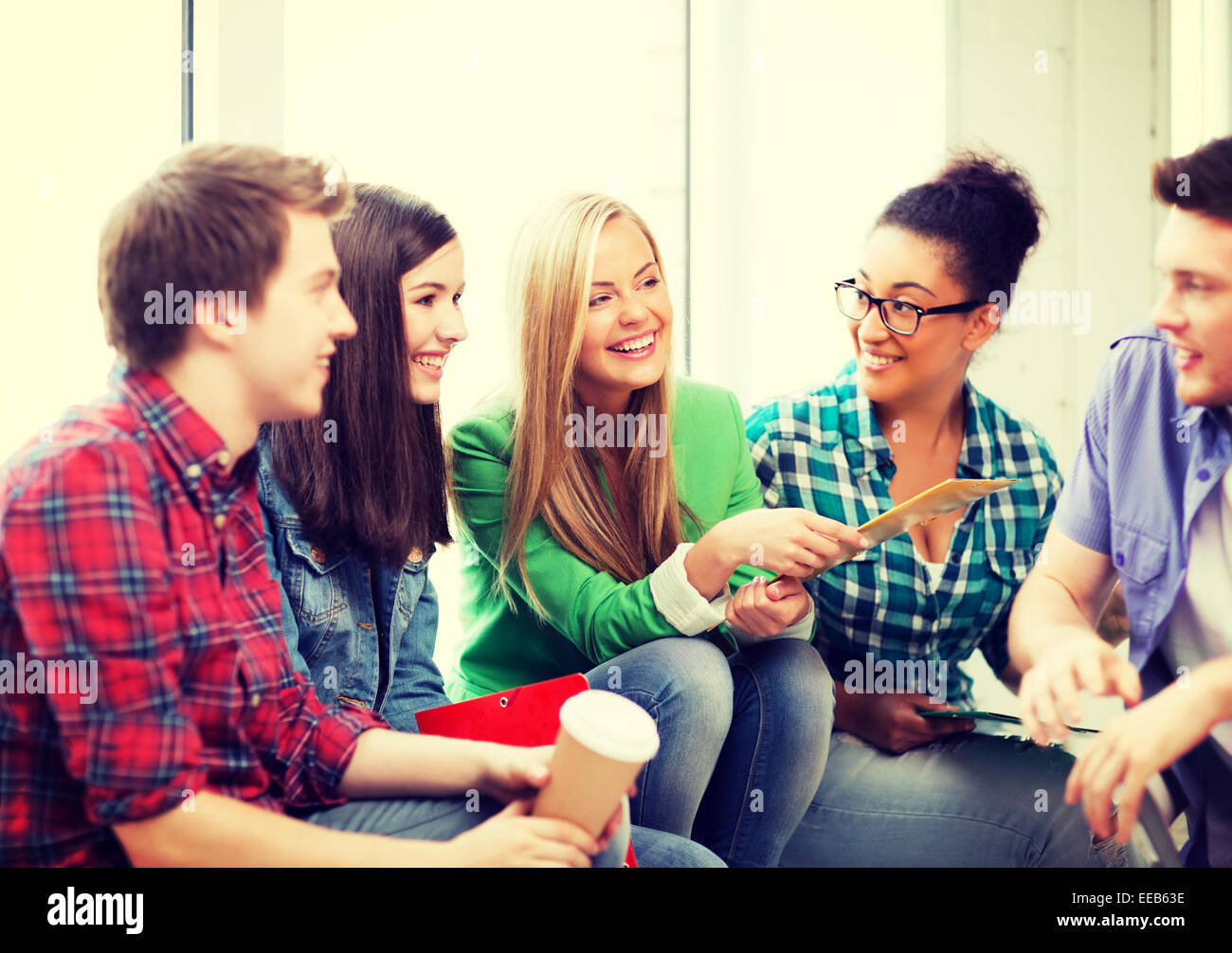 students communicating and laughing at school Stock Photo - Alamy