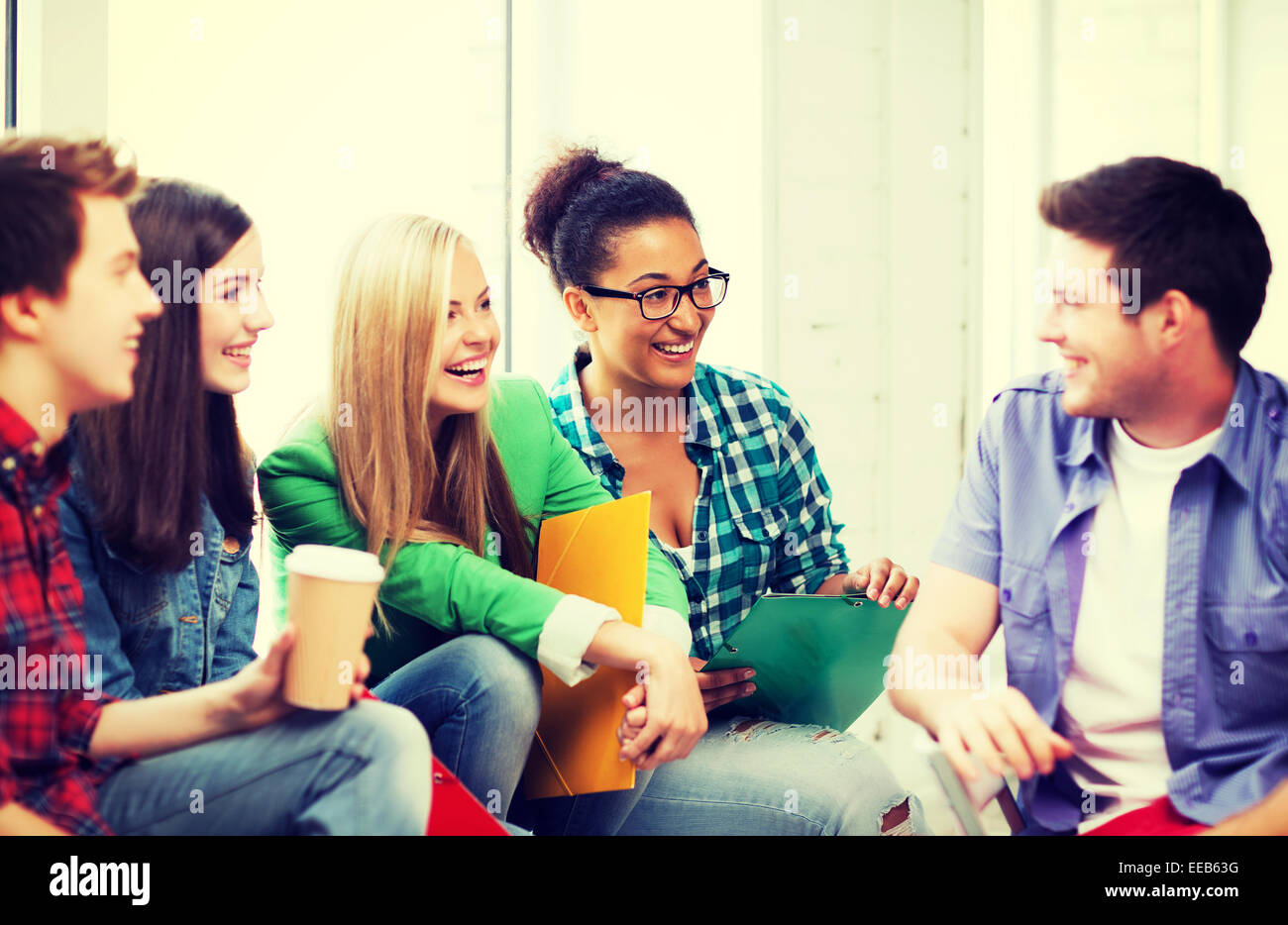 students communicating and laughing at school Stock Photo - Alamy