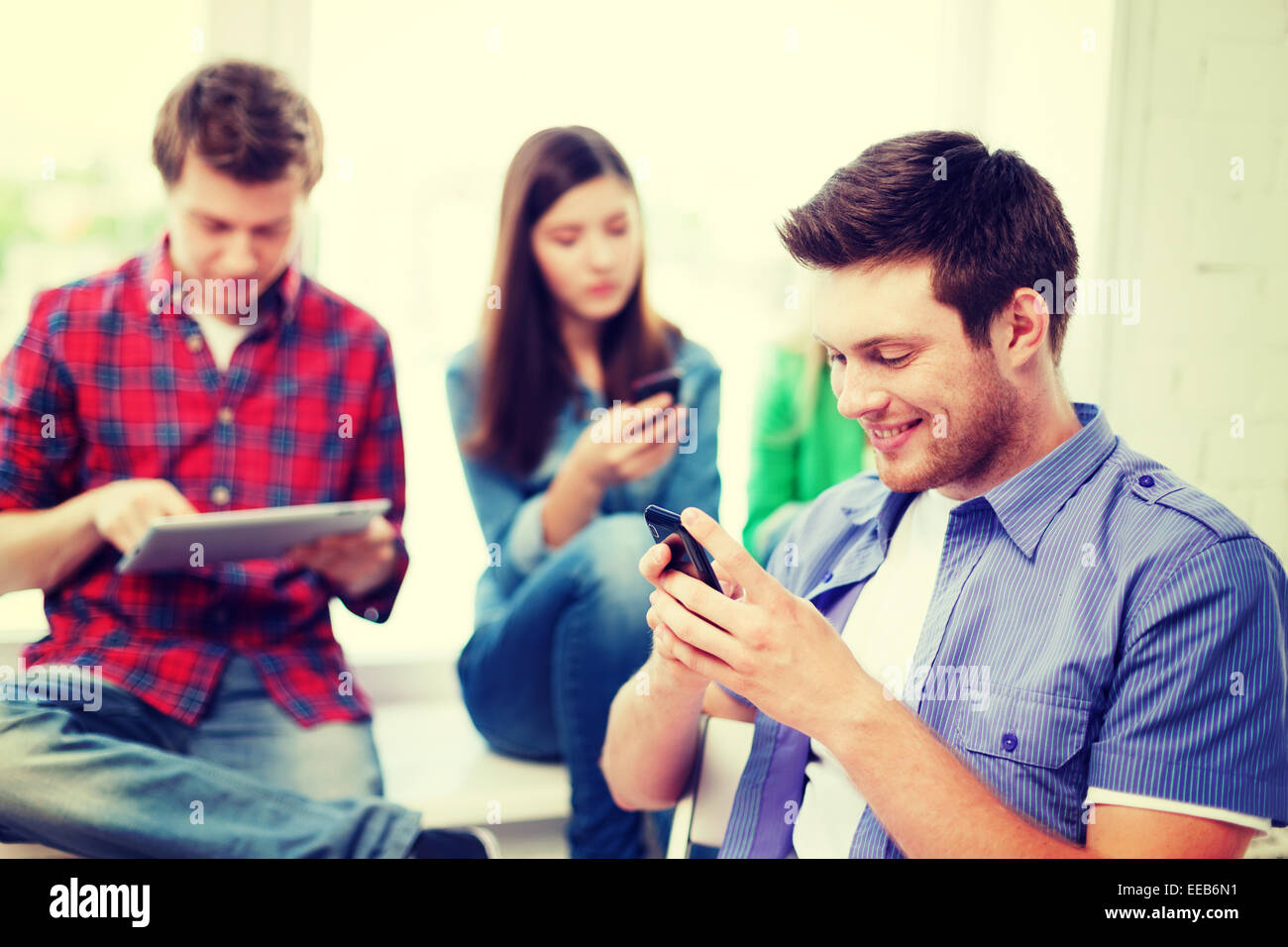 student looking into smartphone at school Stock Photo - Alamy